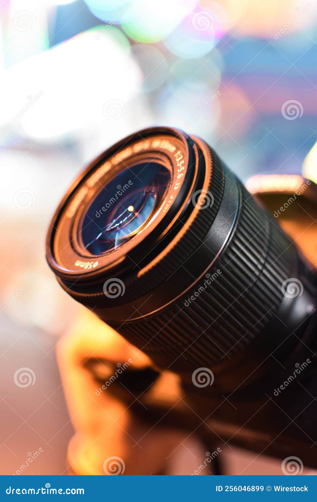 Vertical Shot of a Camera with Bokeh City Lights in the Background ...