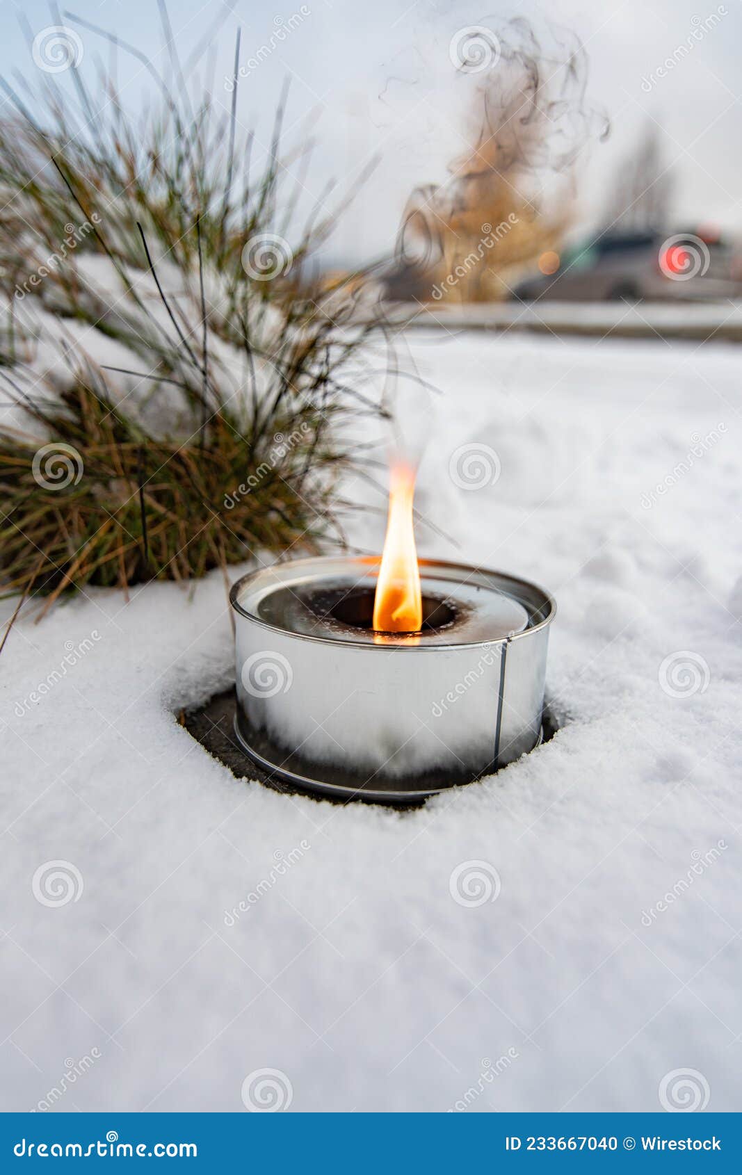 Vertical Shot of a Can with a Fire Flame in the Snow Stock Photo ...