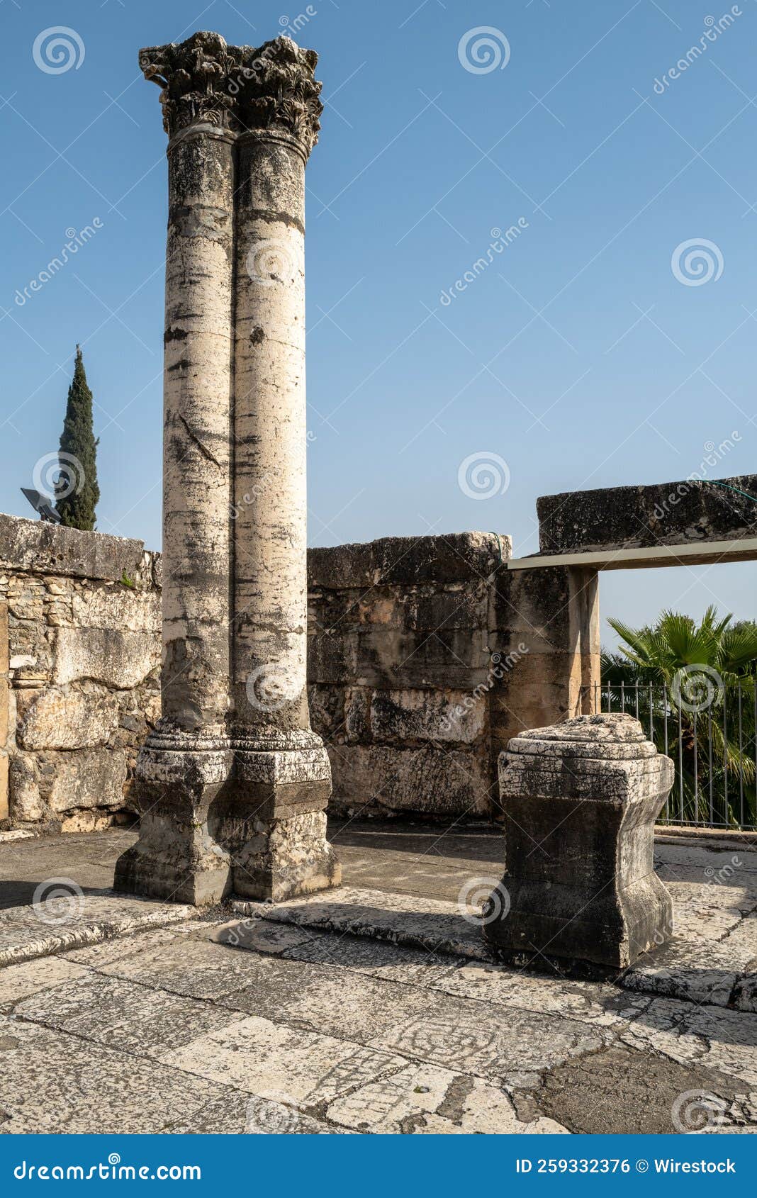 Vertical Shot of Capernaum Synagogue Columns with a Blue Sky in the ...