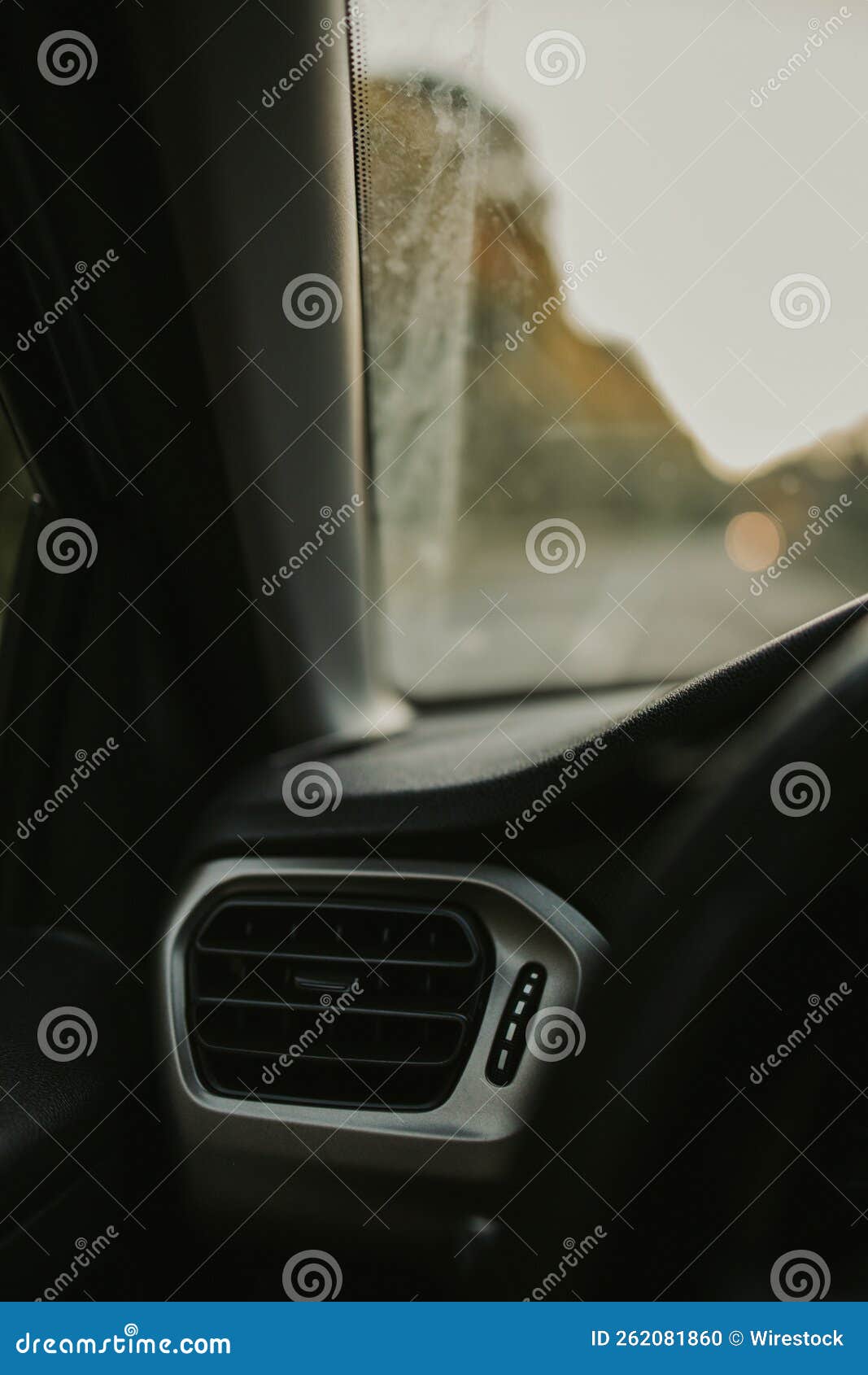 Vertical Shot of a Car Heater with Sunset Visible Behind Windshield in ...
