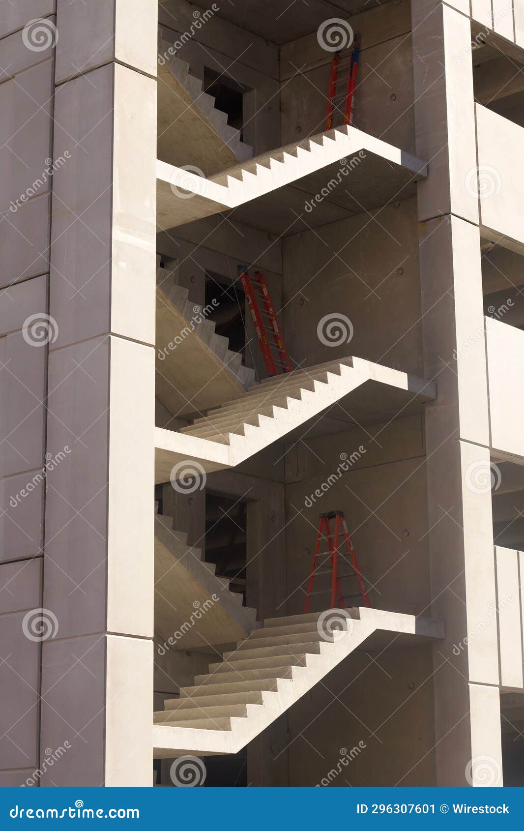 Vertical Shot of a Cement Staircase with Ladders in a Newly Constructed ...