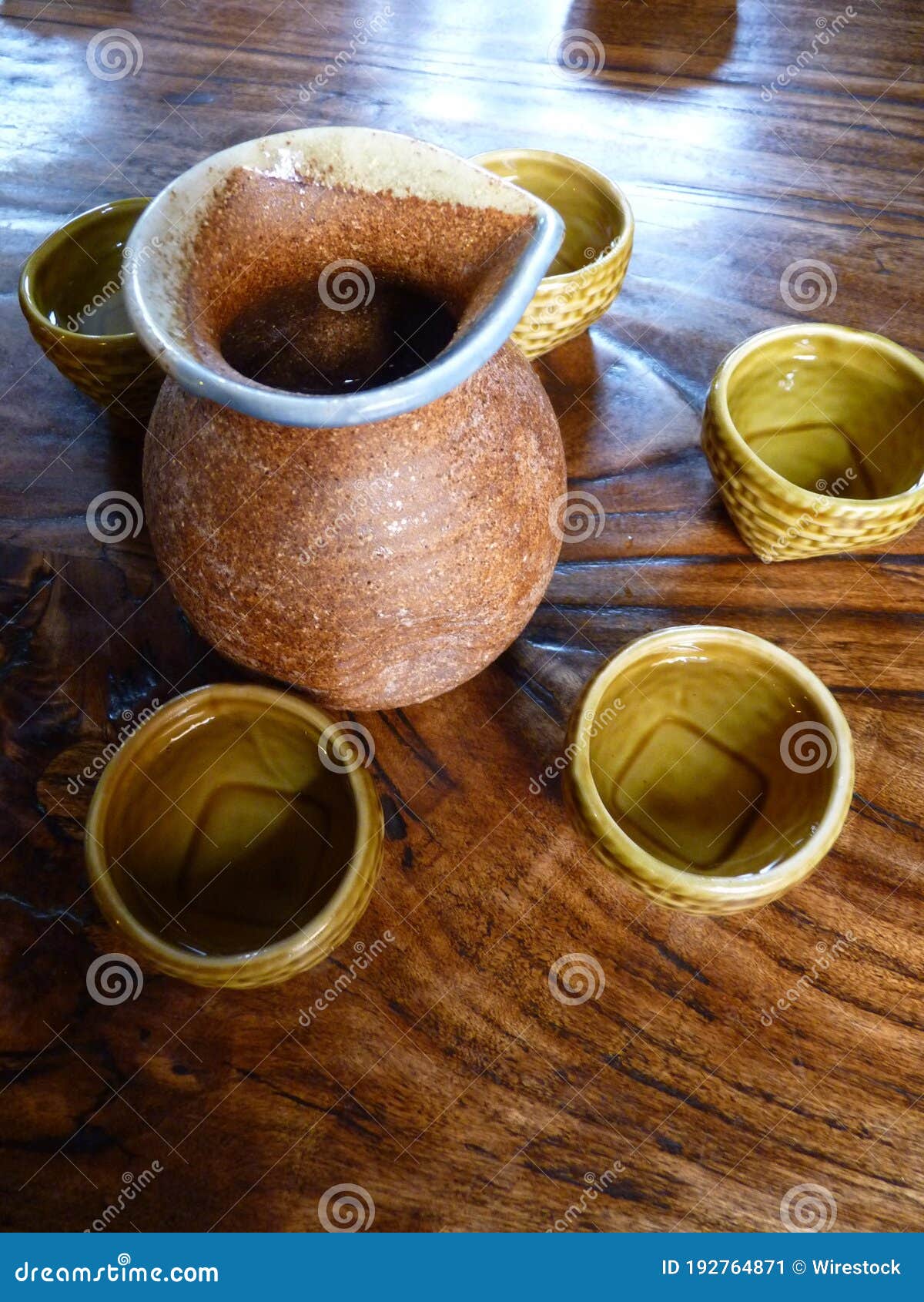 Vertical Shot of Ceramic Pitcher for Tea with Small Teacups Around ...