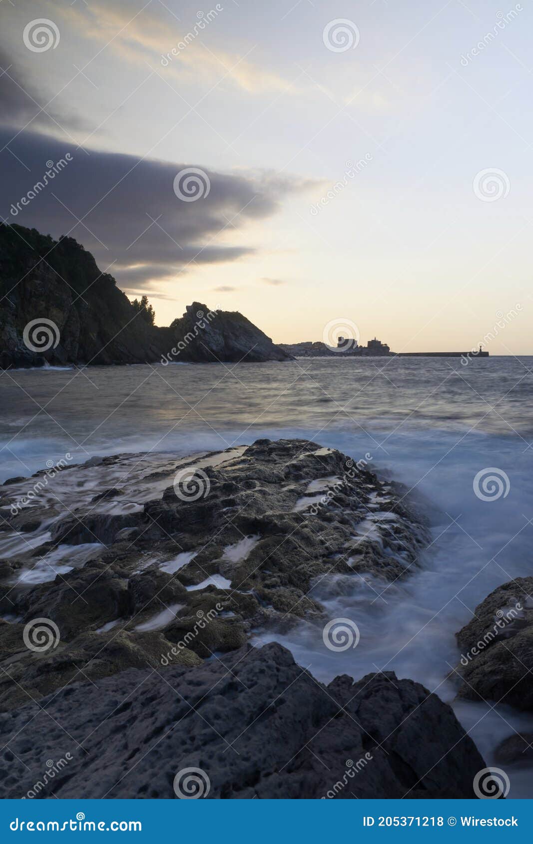 Vertical Shot of a Cliff at a Rocky Beach at Sunset Stock Photo - Image ...