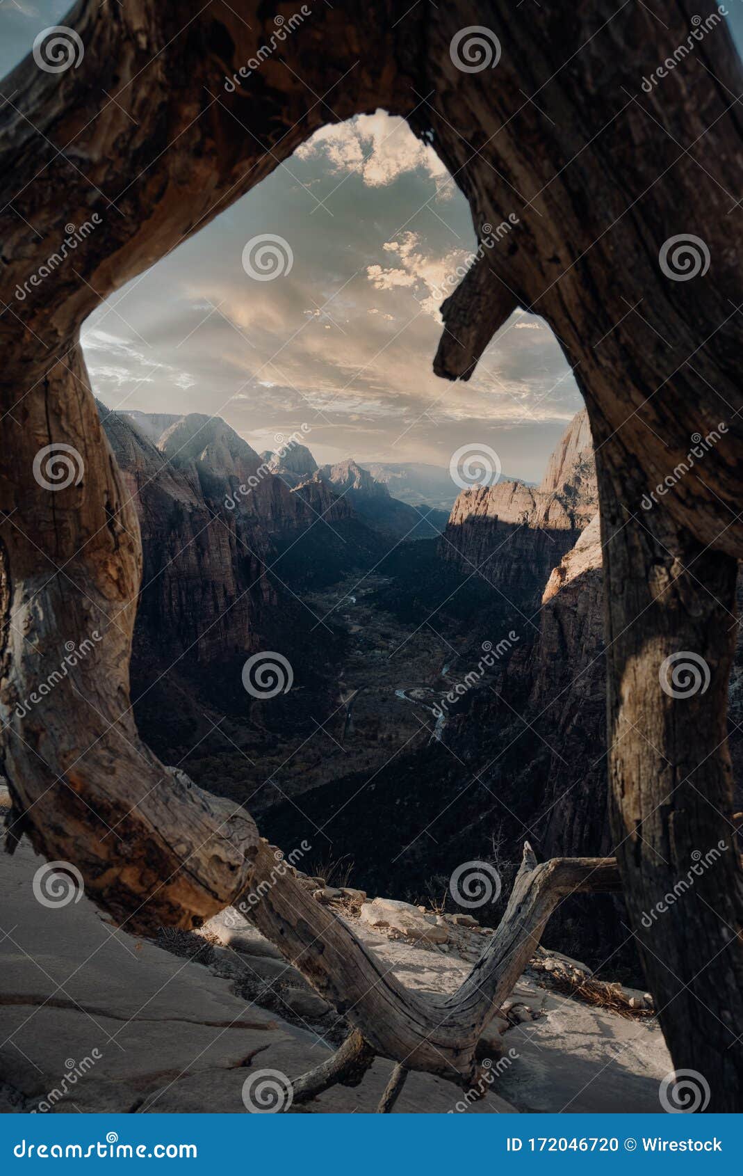 Vertical Shot of the Cliff Under the Cloudy Sky Behind the Circular ...