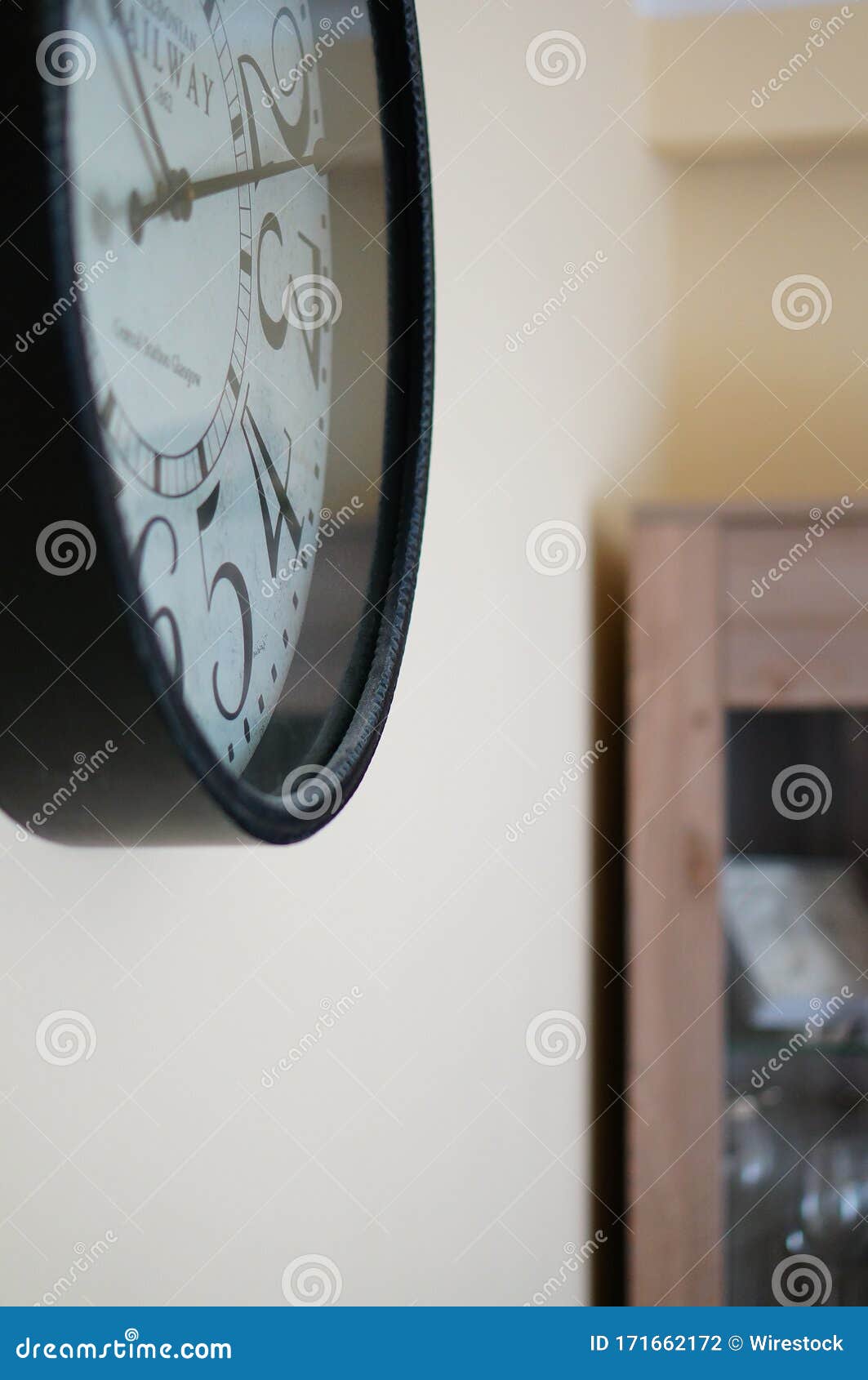 Vertical Shot of a Clock Attached To a Wall Stock Photo - Image of ...