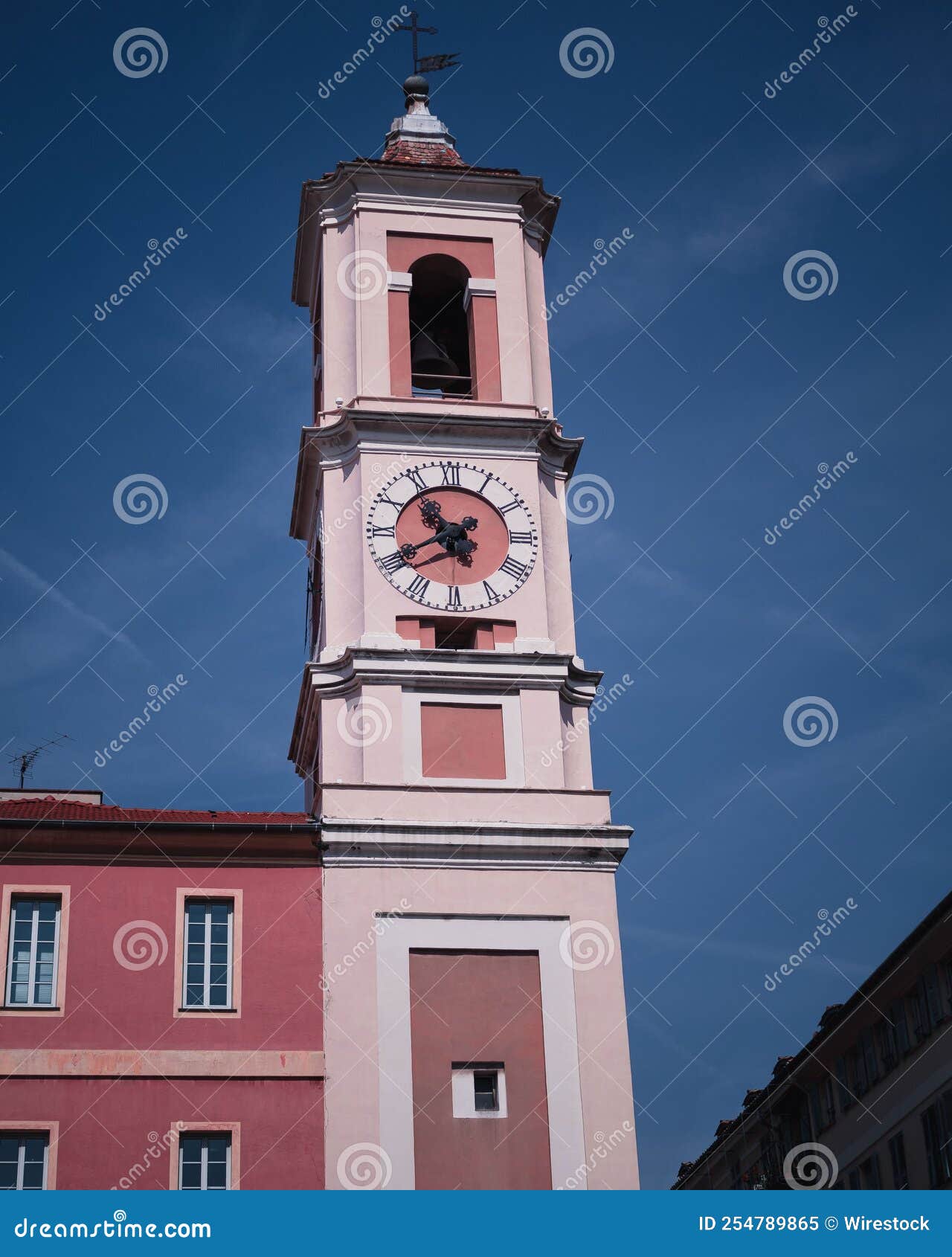 Vertical Shot of a Clock Tower with Cute Pink Architecture with a Blue ...
