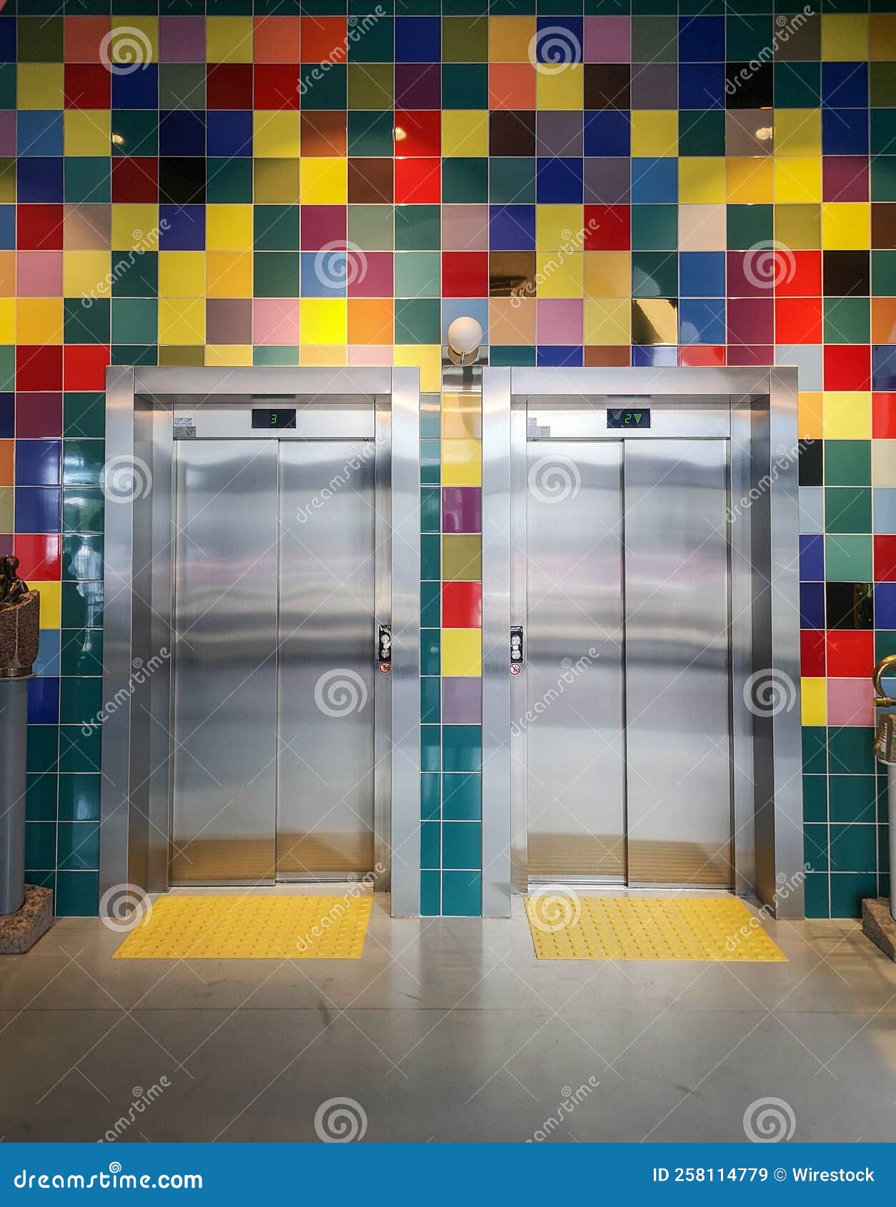 Vertical Shot of Colorful Checkered Facade of an Elevator with Silver ...