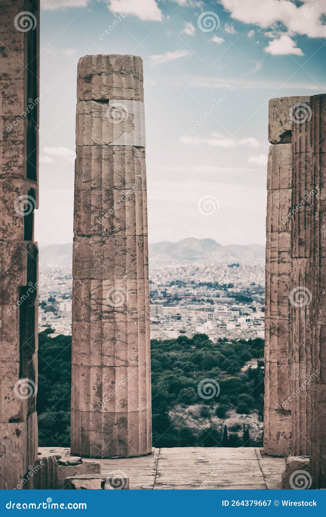 Vertical Shot of Column Ruins on the Background of a Cityscape Stock ...