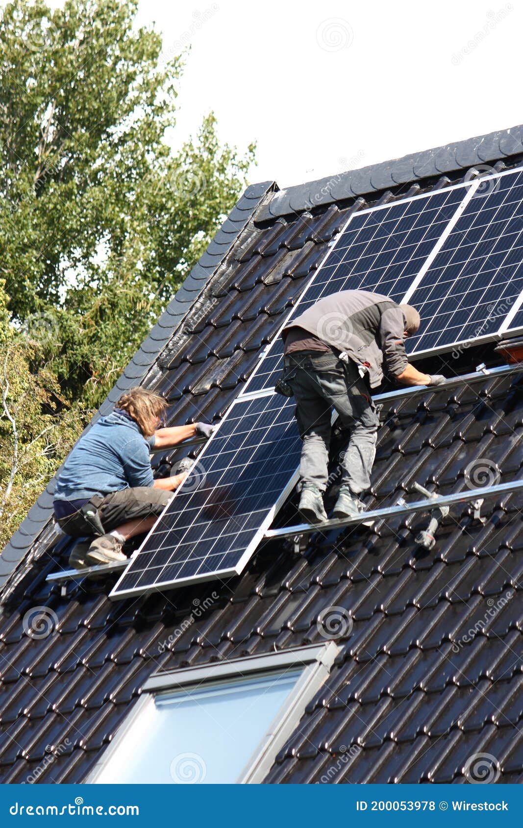 Vertical Shot of Construction Workers Installing Solar Panels To a Roof ...