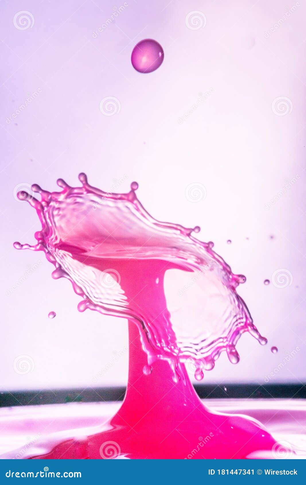 Vertical Shot of a Cool Pink Water Splash Against a Blurred Background ...