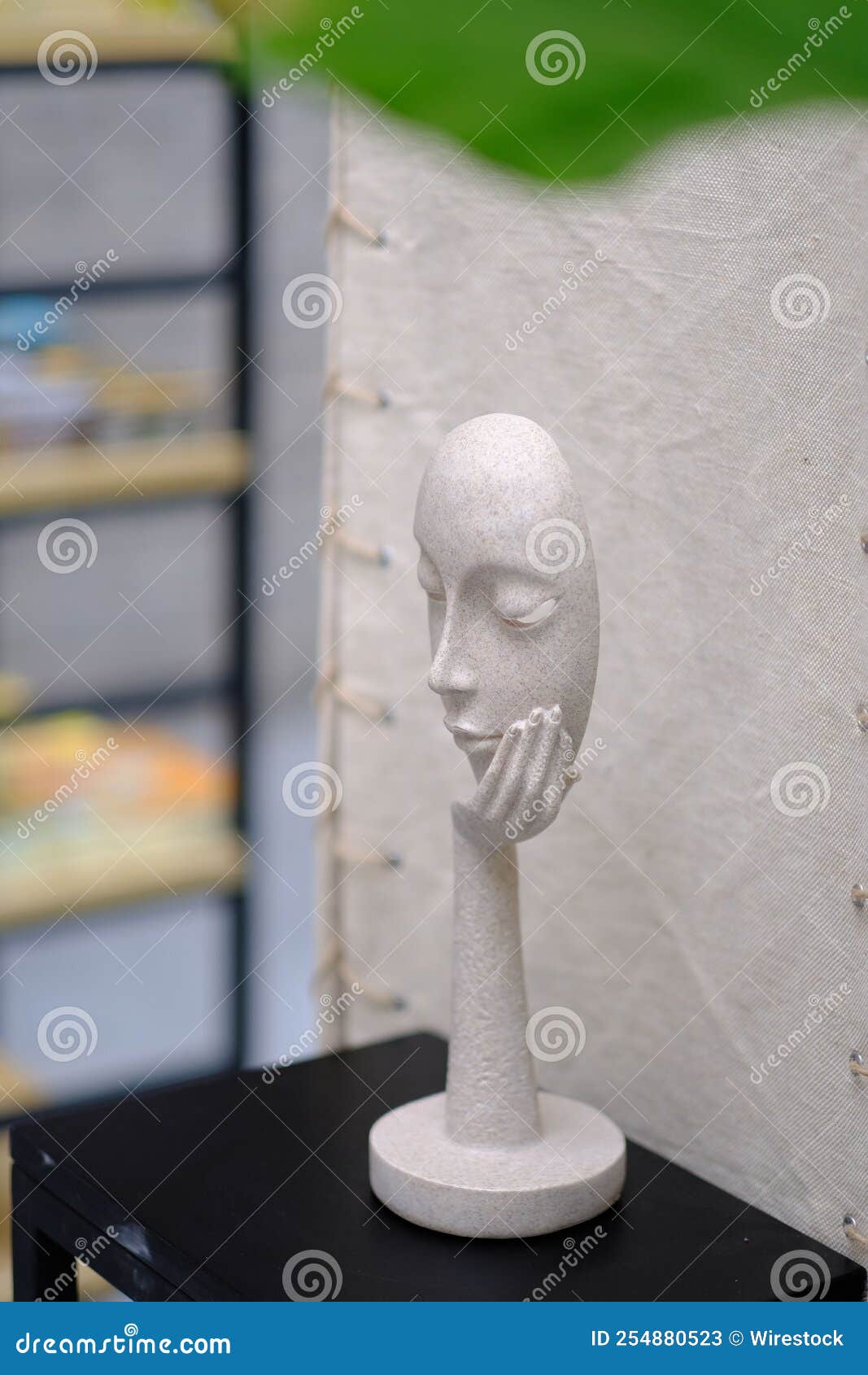 Vertical Shot of a Creative White Statue with a Hand Holding a Face ...