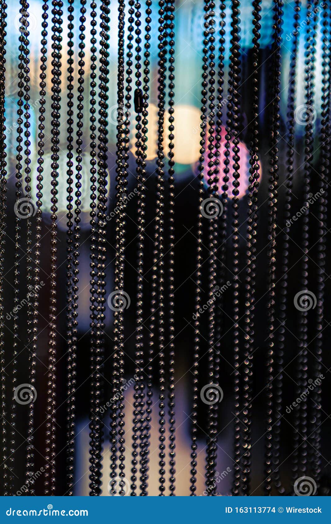 Vertical Shot of Decorative Glitter String Curtain with Bokeh Lights in ...