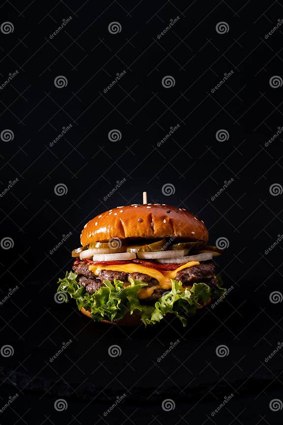 Vertical Shot of a Delicious Burger on a Black Surface Stock Image ...