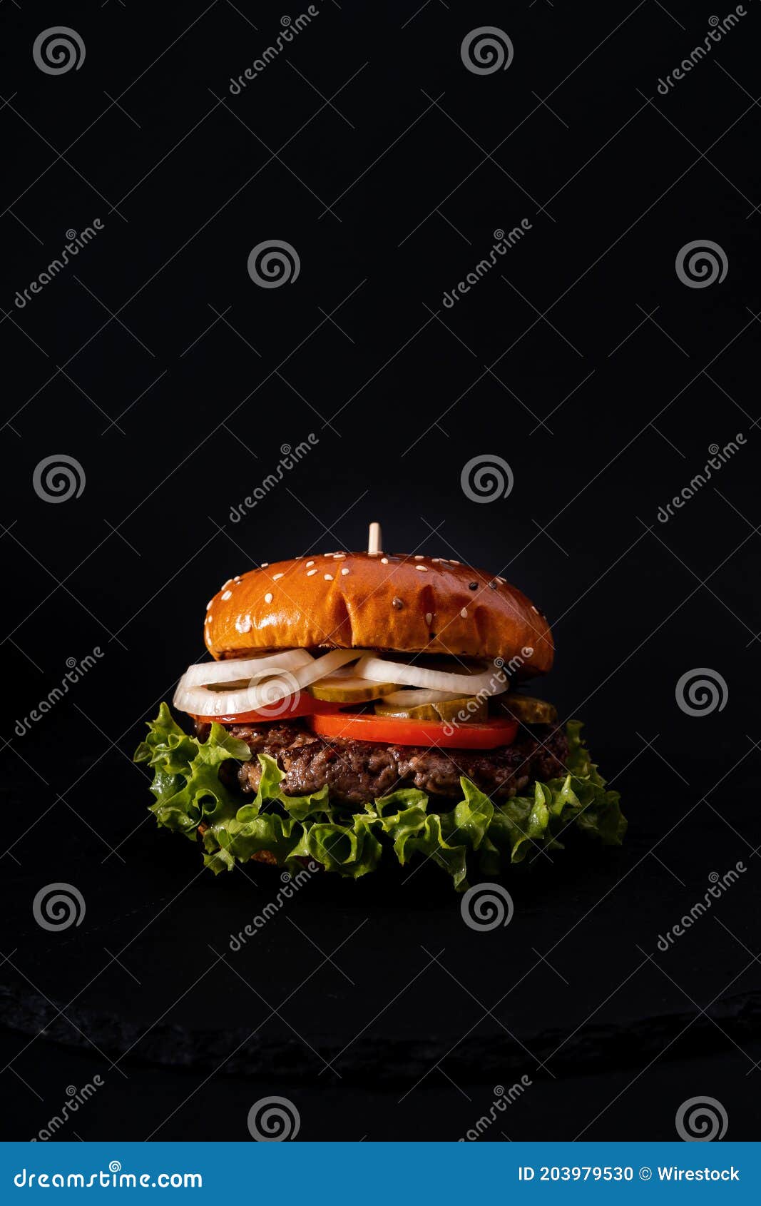 Vertical Shot of a Delicious Burger on a Black Surface Stock Photo ...