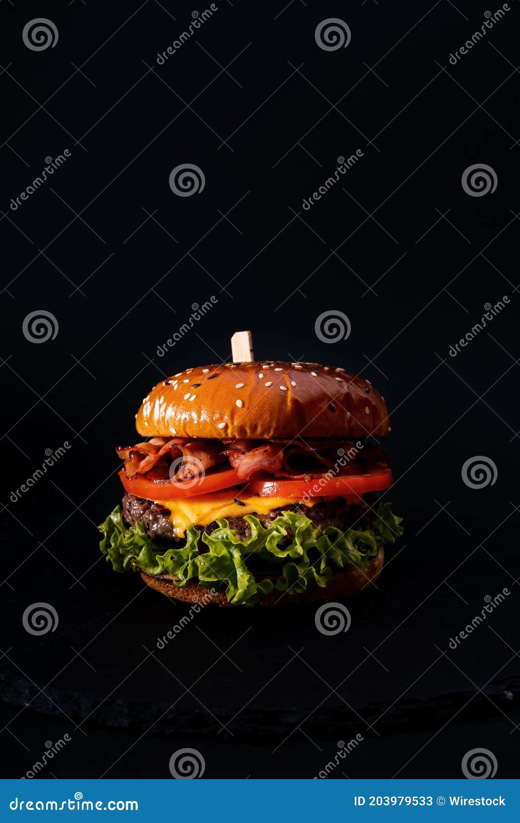 Vertical Shot of a Delicious Burger on a Black Surface Stock Image ...