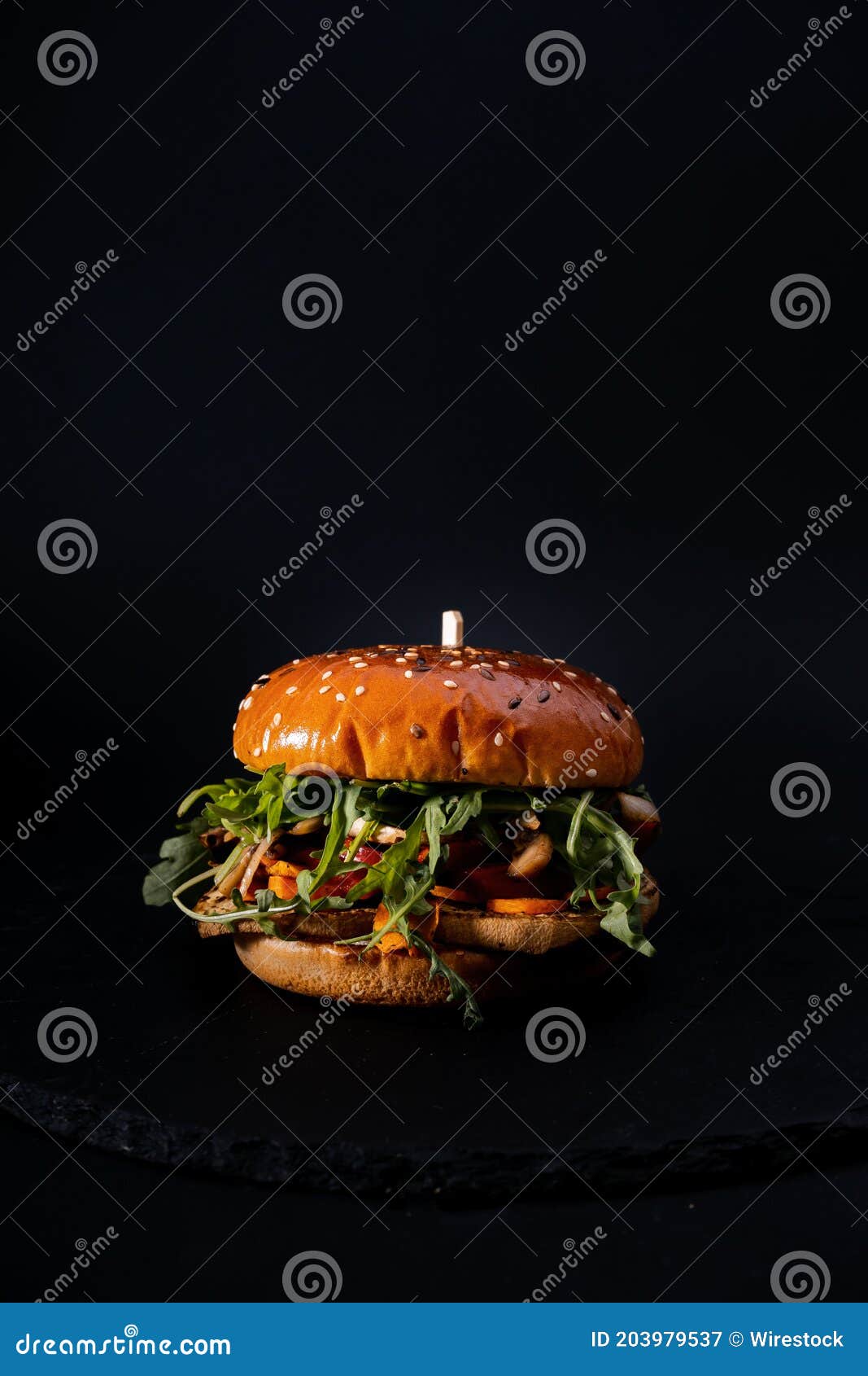Vertical Shot of a Delicious Burger on a Black Surface Stock Image ...