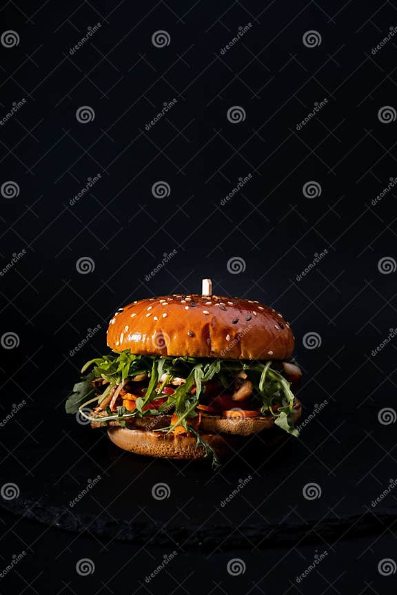 Vertical Shot of a Delicious Burger on a Black Surface Stock Image ...