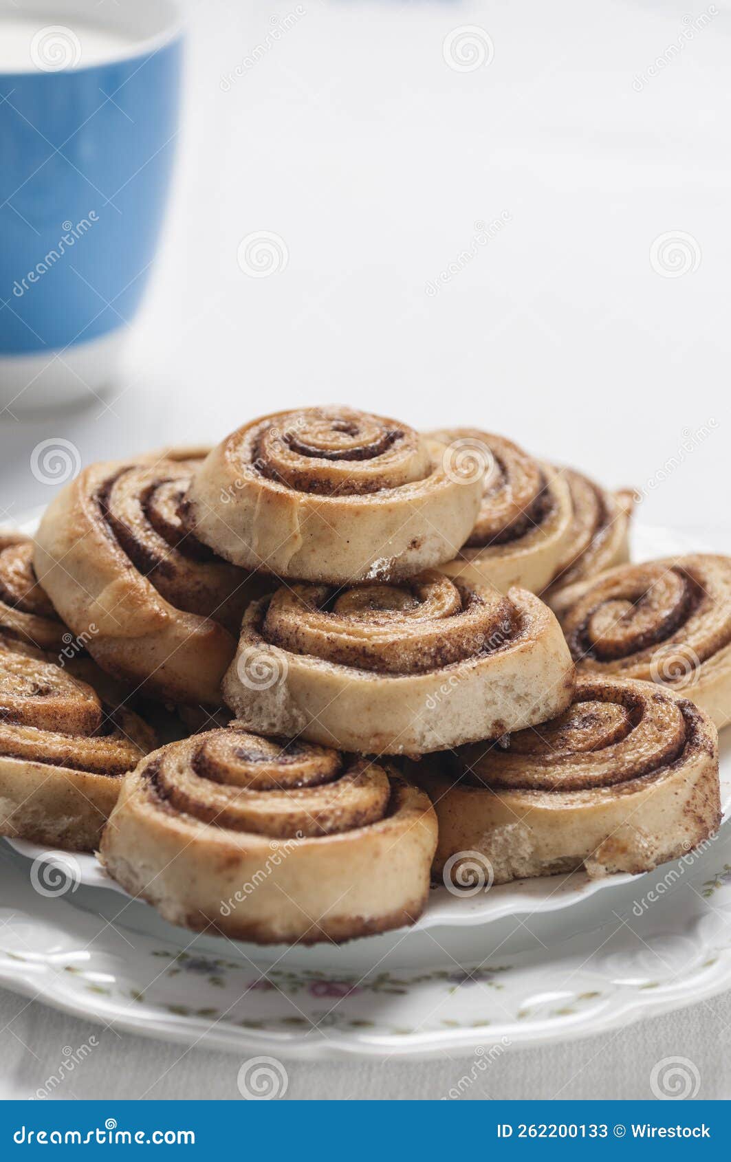 Vertical Shot of Delicious Cinnamon Rolls and a Cup of Milk Stock Image ...