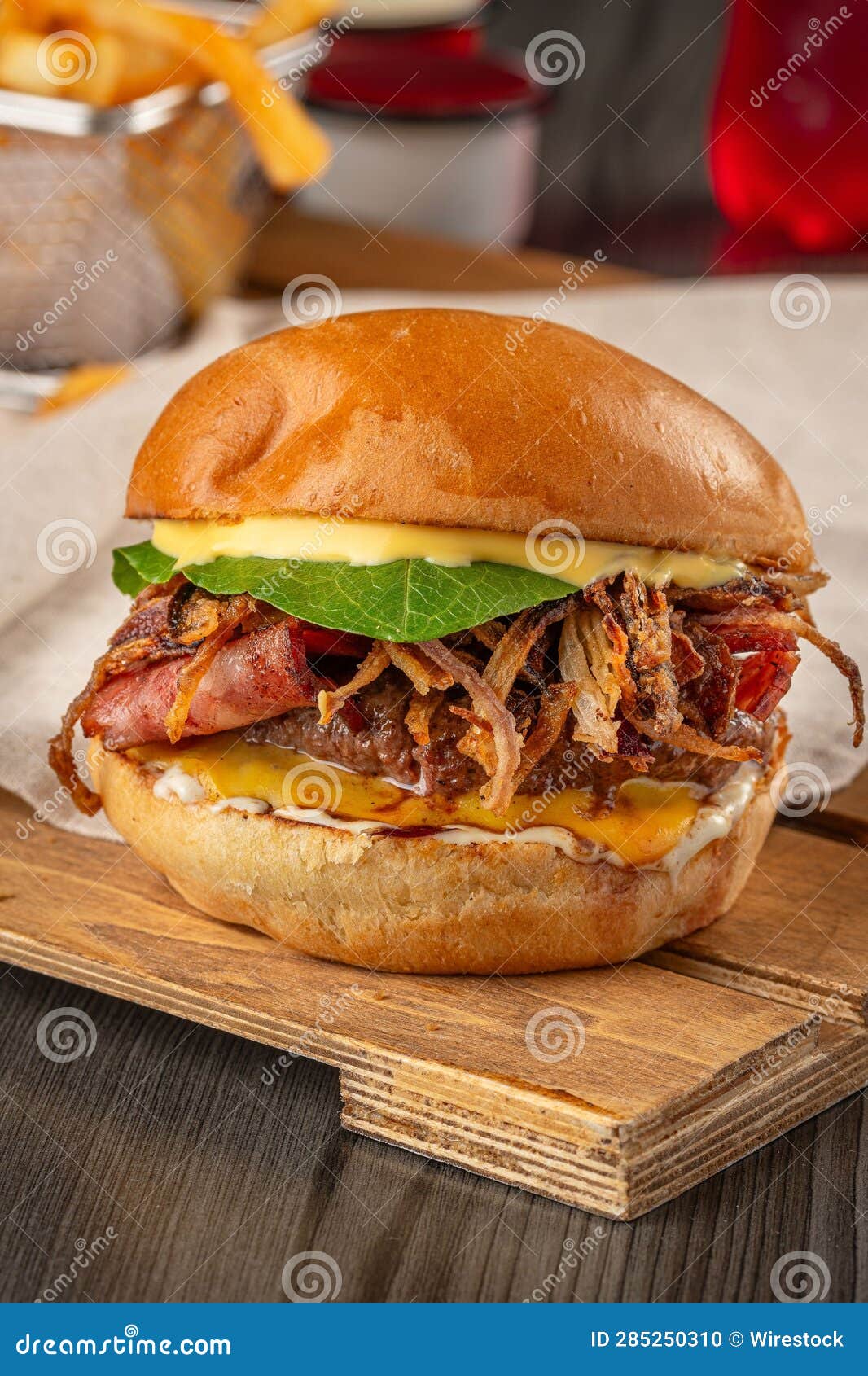 Vertical Shot of a Delicious Hamburger with Onion and Ham on the Table ...