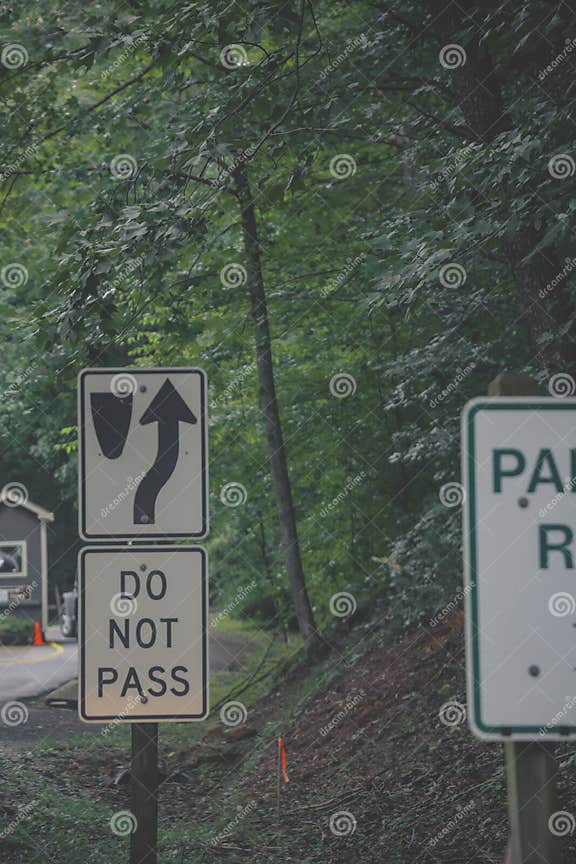 Vertical Shot of Do Not Pass Sign Text in the Forest with Trees Stock ...