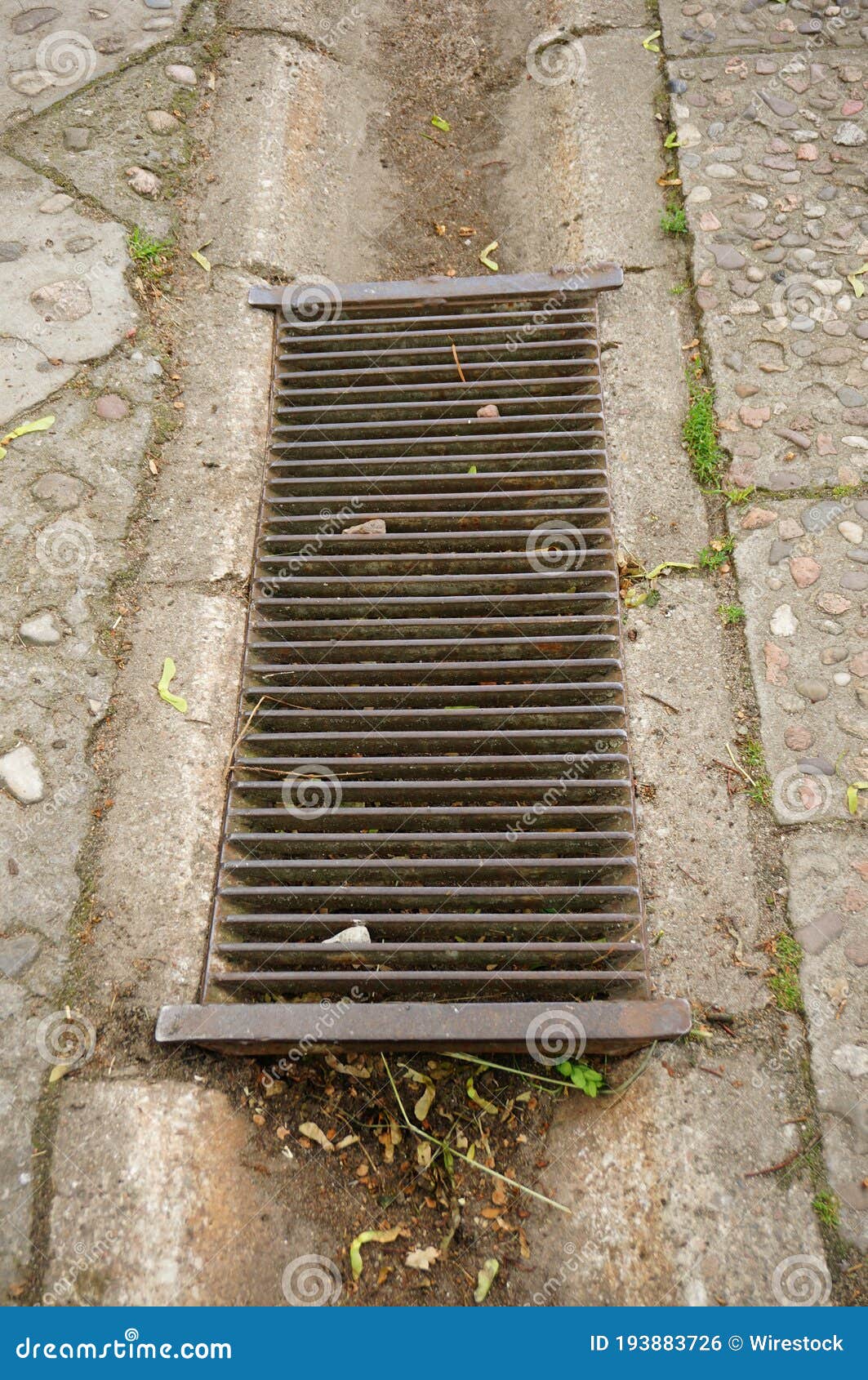 Vertical Shot of Drainage Grates Along the Road Stock Photo - Image of ...