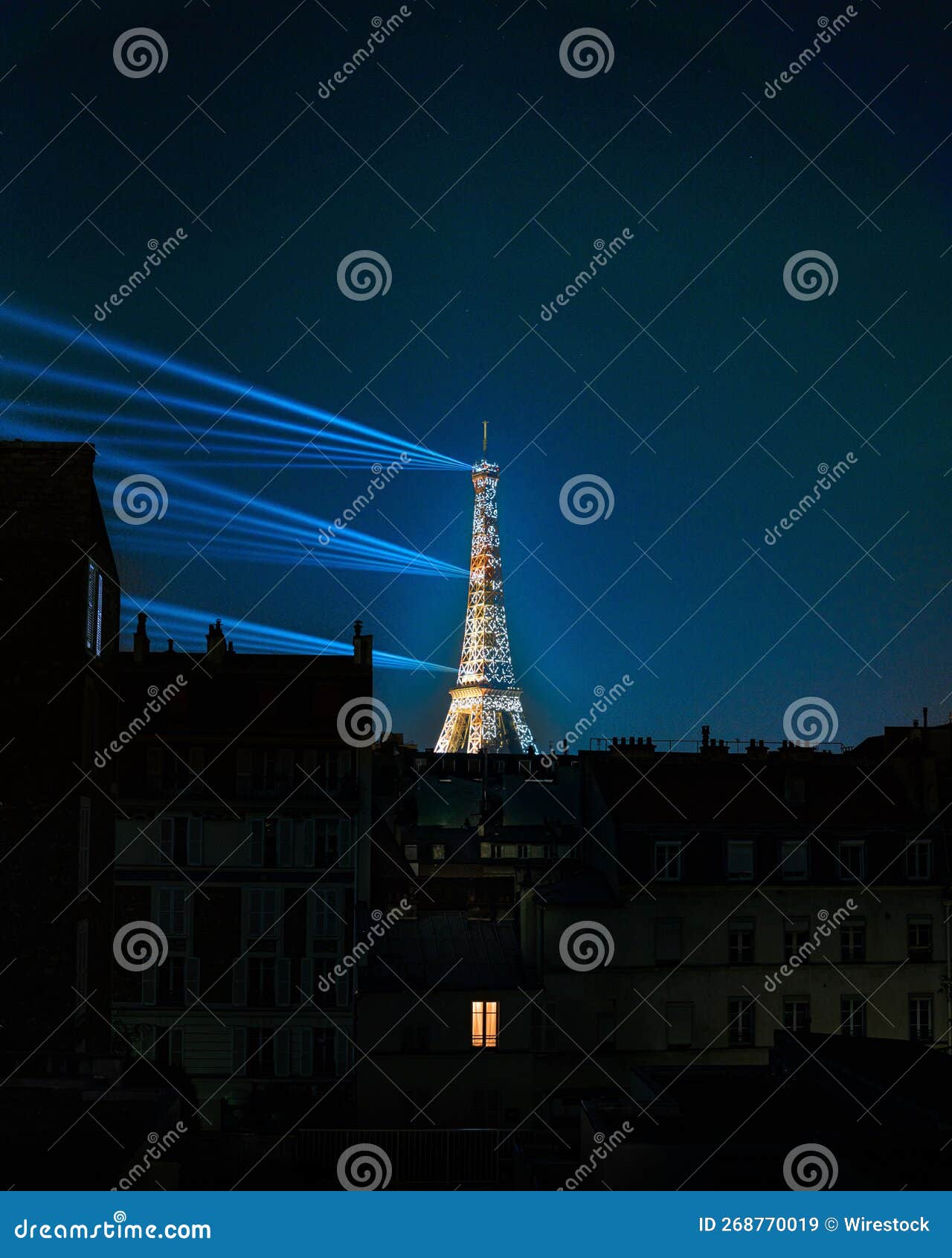Vertical Shot of the Eiffel Tower Beaming Blue Lights in the Night Sky ...