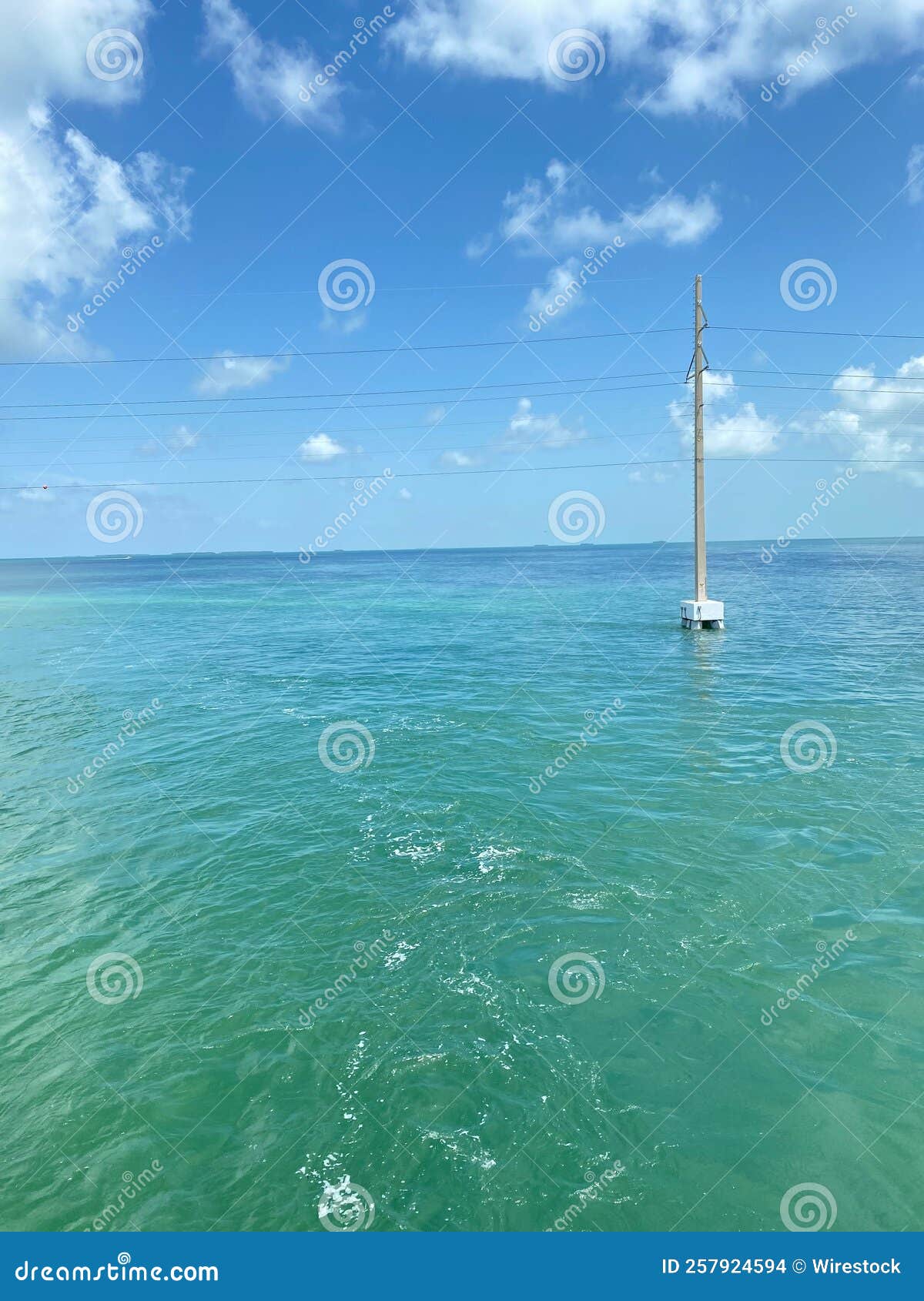 Vertical Shot of an Electric Pylon in the Ocean. Stock Photo - Image of ...