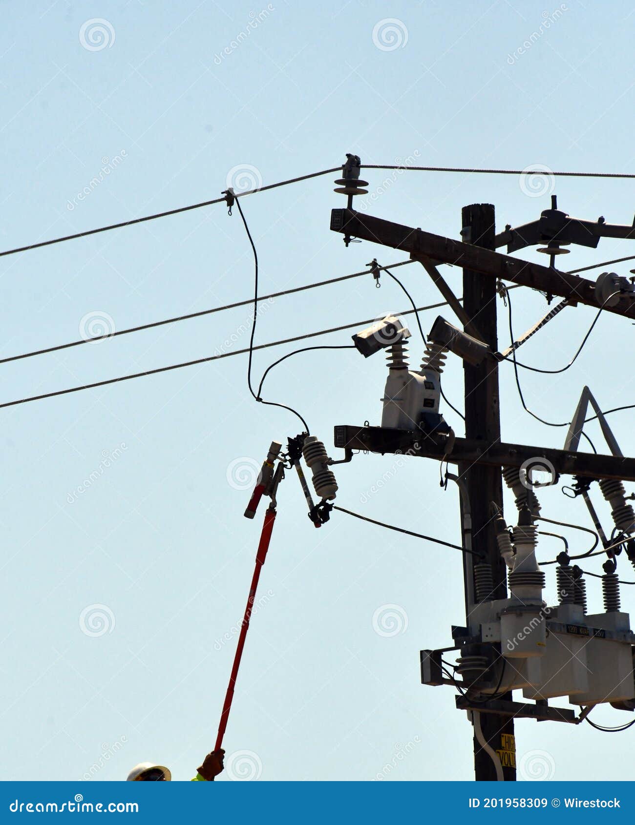Vertical Shot of an Electrical Power Post Under the Sunlight and a Blue ...