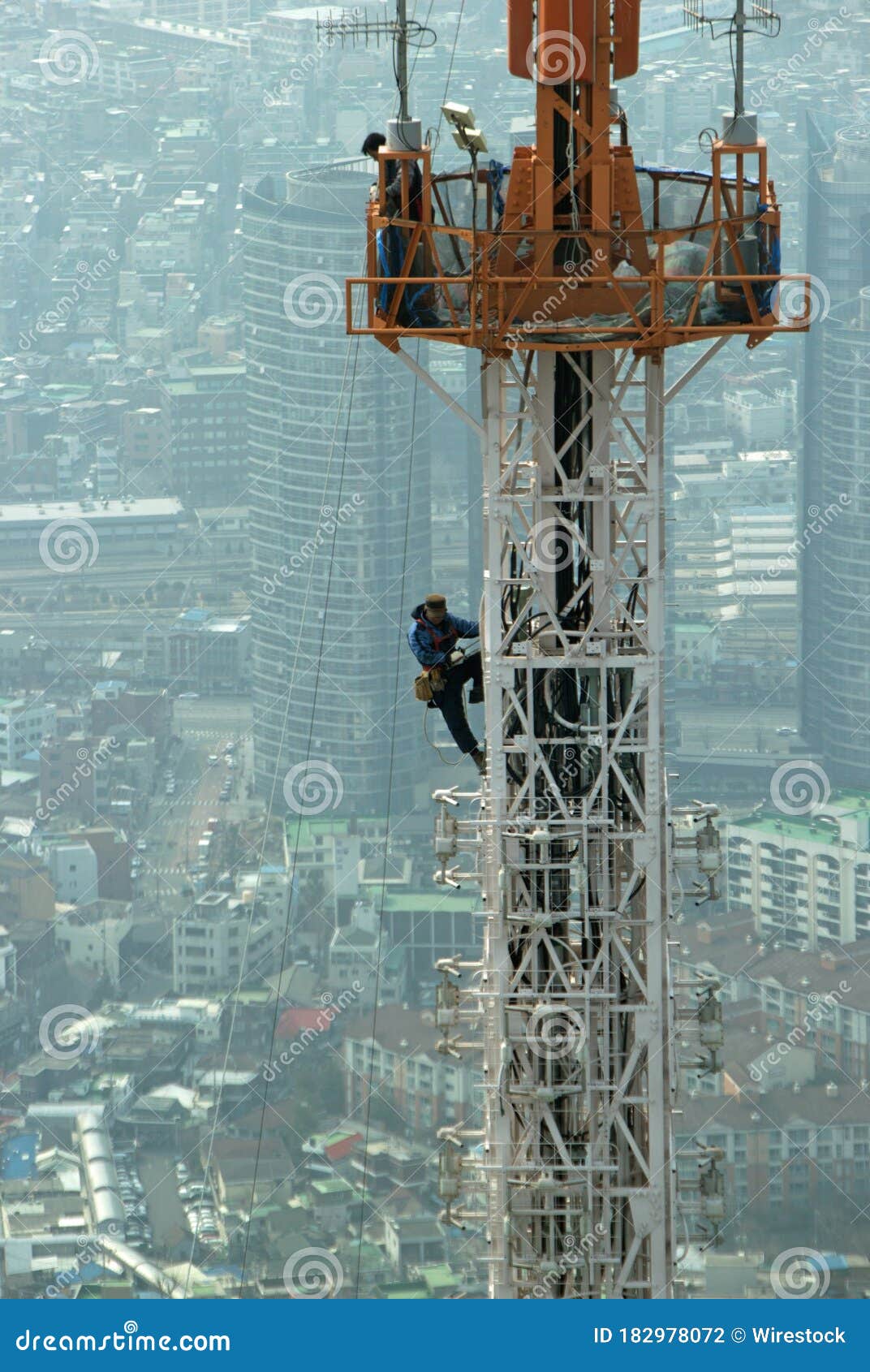 Vertical Shot of an Electrical Tower with People Climbing and Doing ...