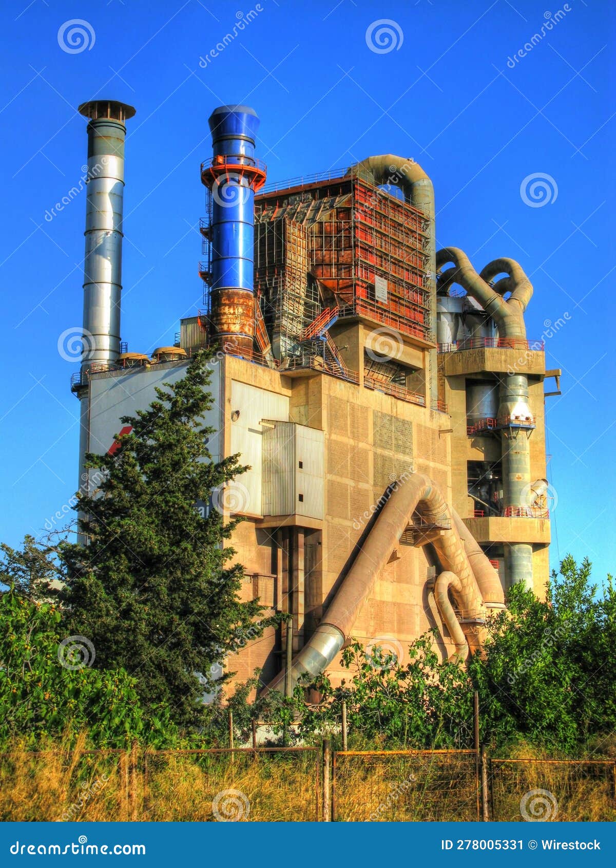 Vertical Shot of a Factory Structure Showcasing a Multitude of Piping ...