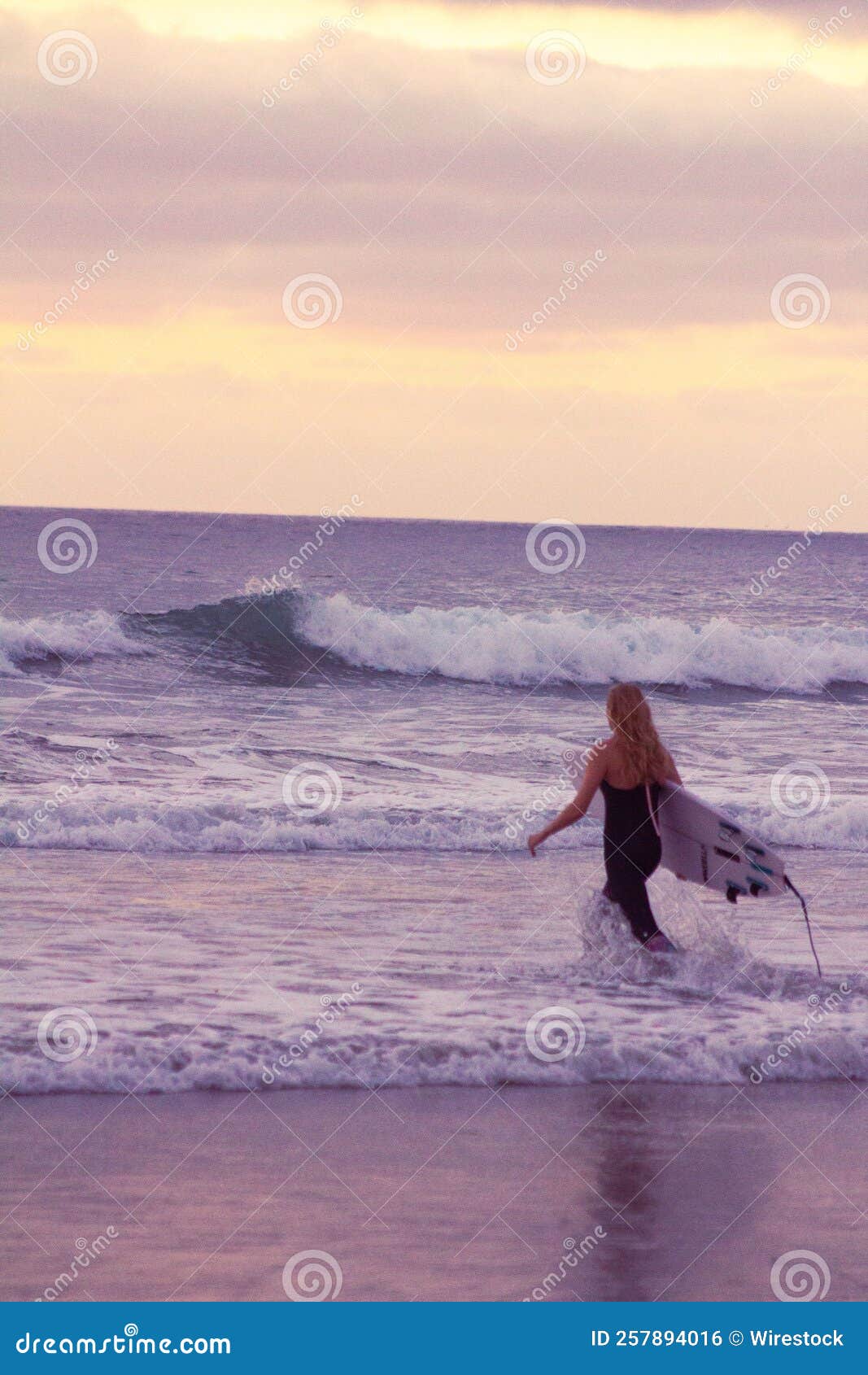 Vertical Shot of a Female Surfing at Sunset Stock Photo - Image of ...