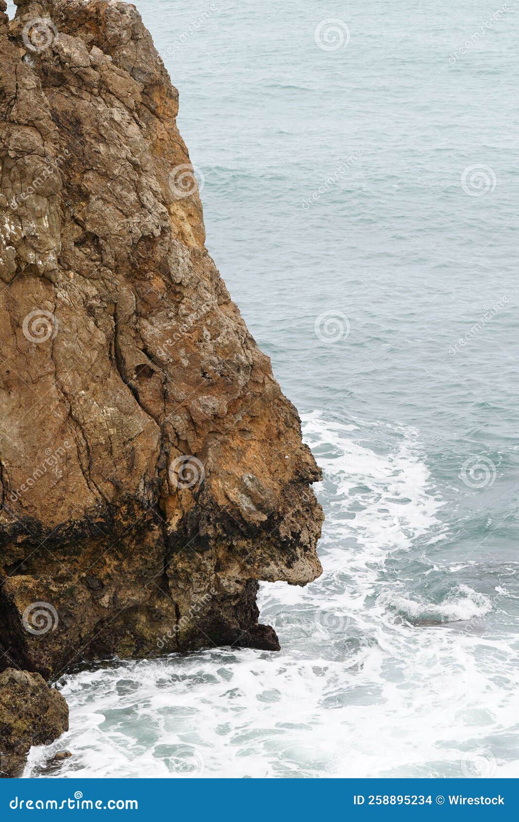 Vertical Shot of Foamy Ocean Waves Hitting a Big Cliff Stock Photo ...