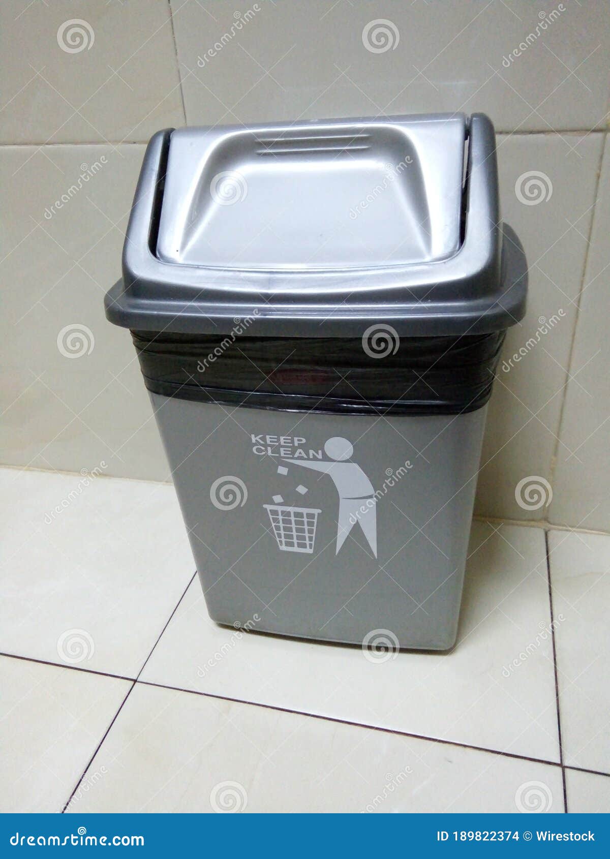 Vertical Shot of a Gray Trash Can Next To the Wall Stock Photo - Image ...