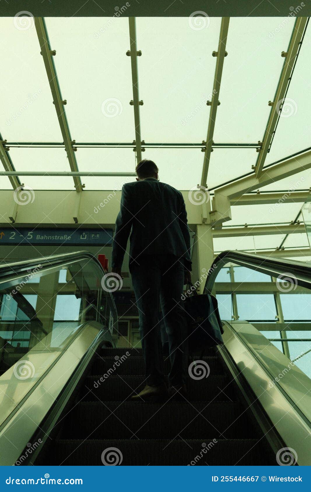 Vertical Shot of a Guy Going Up on an Escalator Inside a Building Stock ...