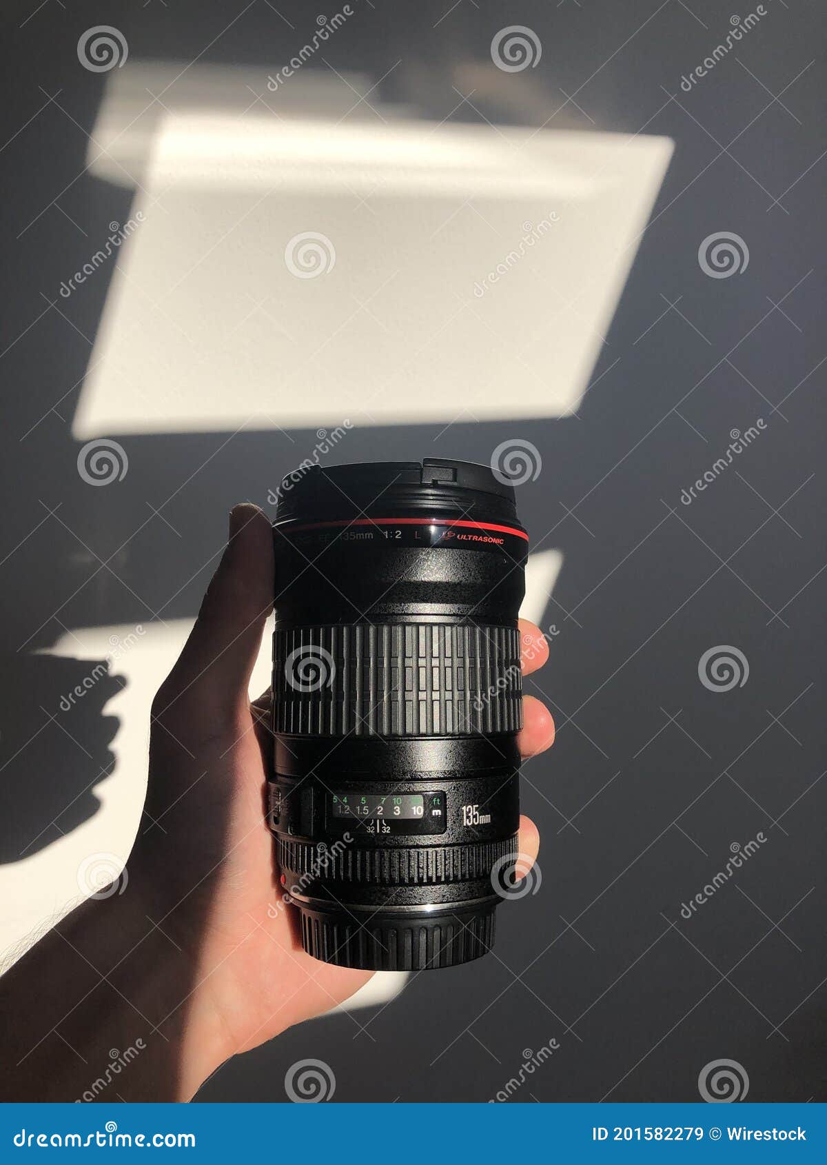 Vertical Shot of a Hand Holding Camera Lens Stock Image - Image of ...