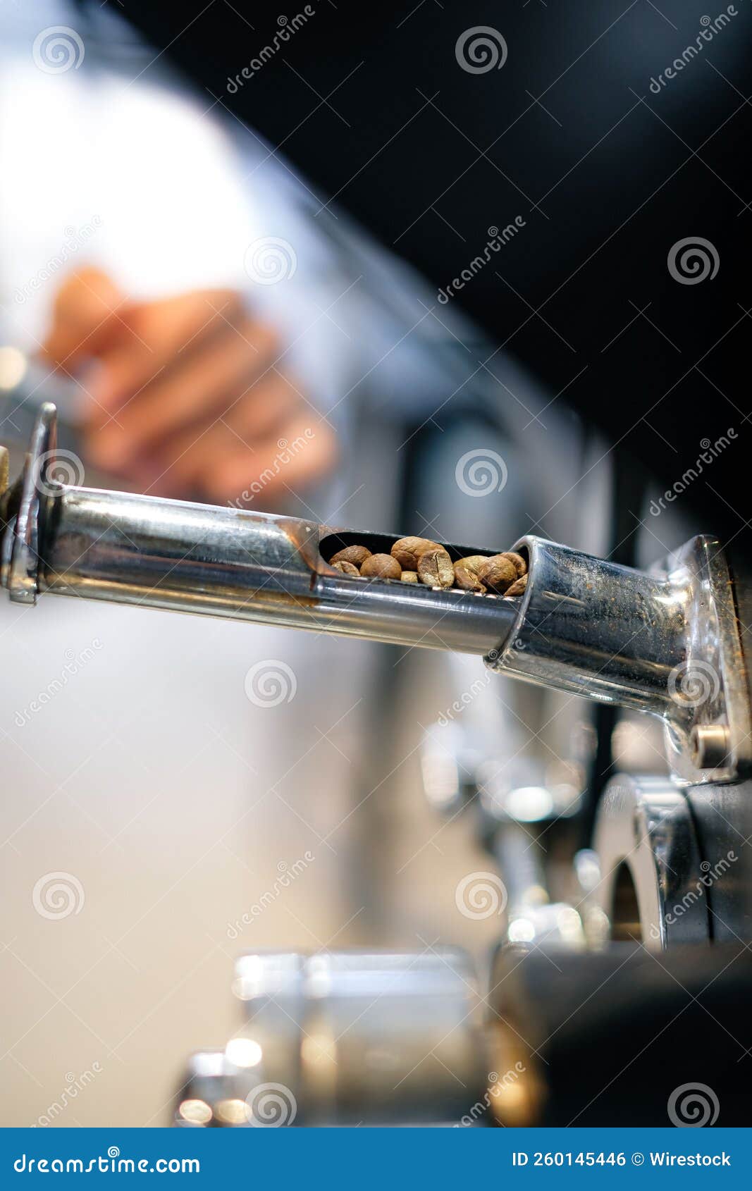 Vertical Shot of a Hand Holding a Thin Coffee Roaster with Beans Inside ...