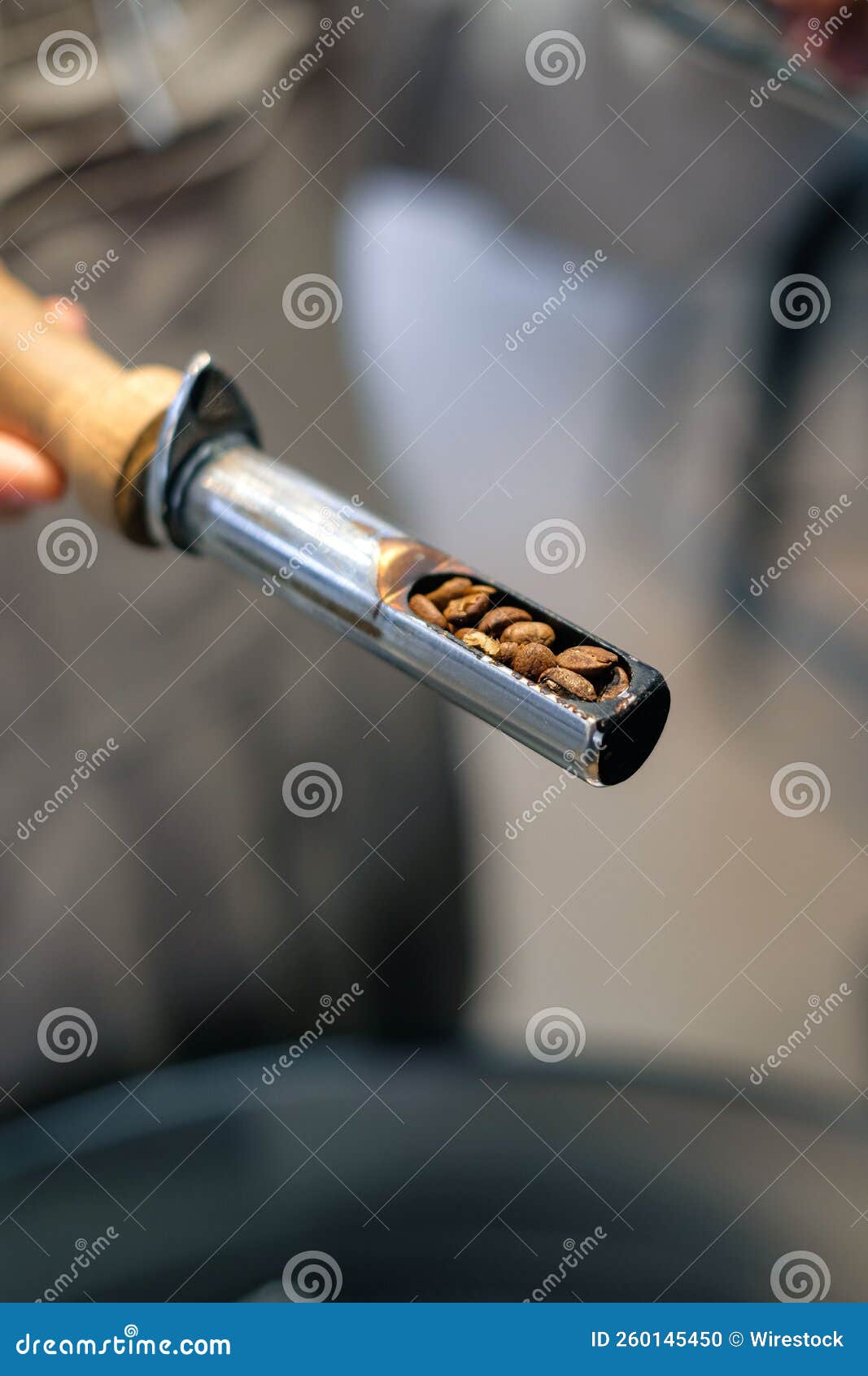 Vertical Shot of a Hand Holding a Thin Coffee Roaster with Beans Inside ...