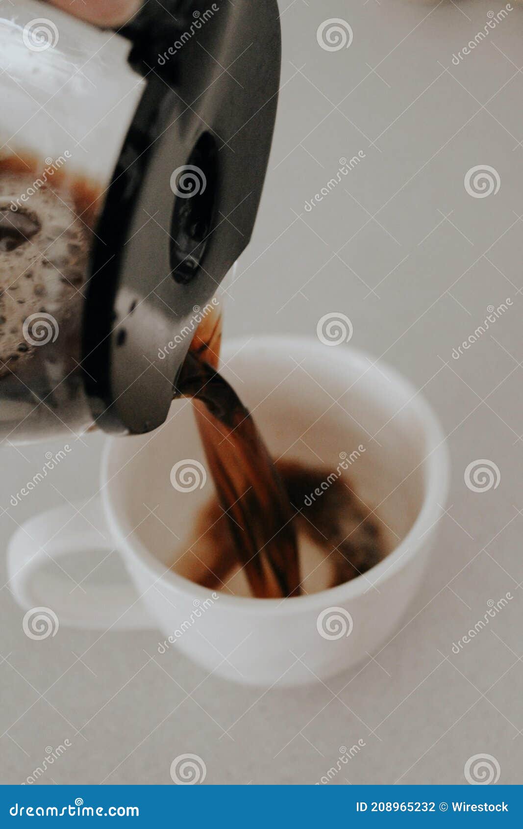 Vertical Shot of Hot Coffee Pouring into a White Cup Stock Photo ...