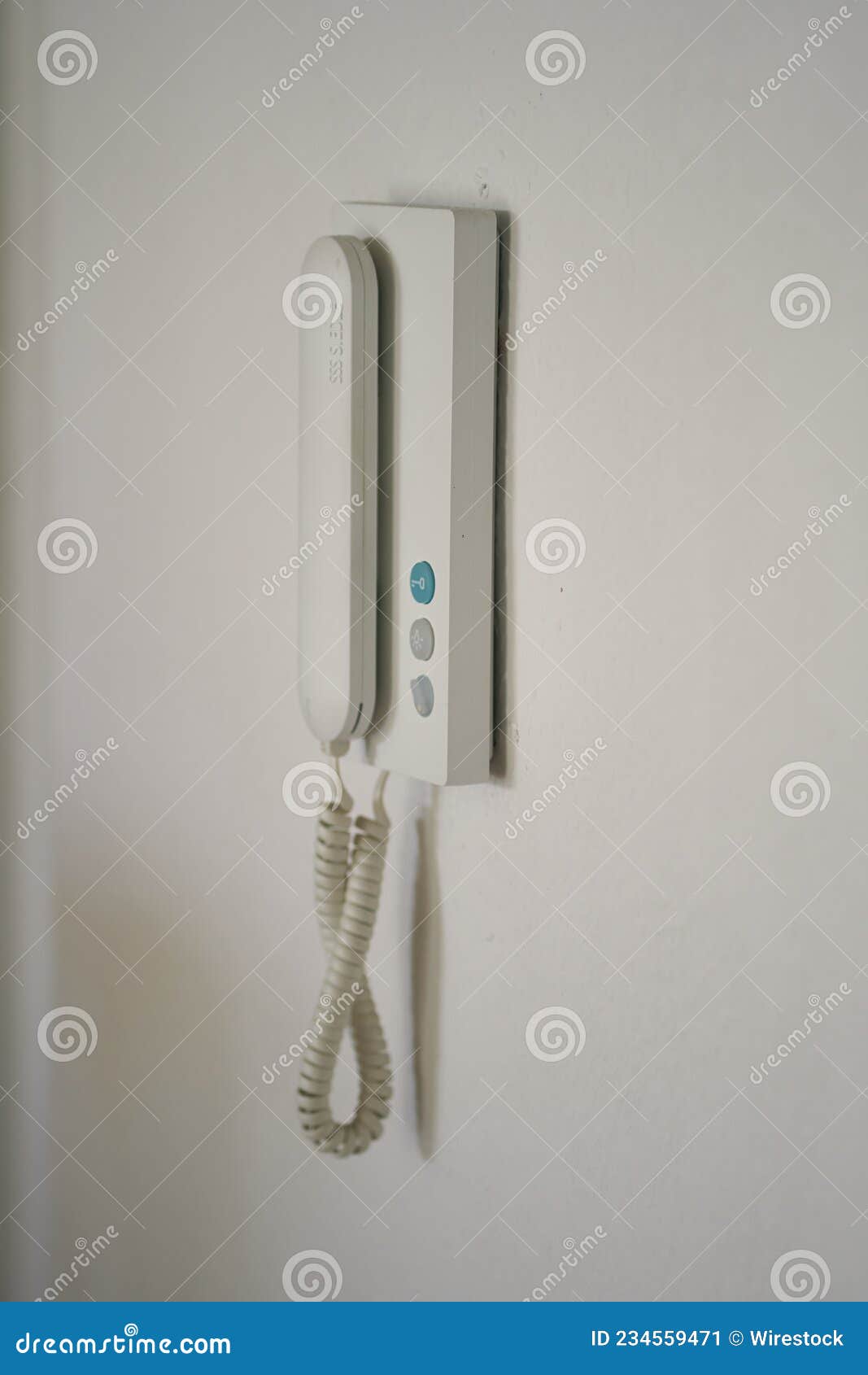 Vertical Shot of an Intercom Receiver on a White Wall in the Apartment ...