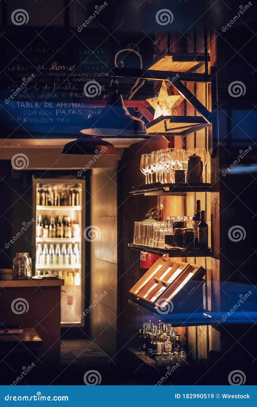 Vertical Shot of an Interior of a Pub with Glasses and a Bar at Lights ...