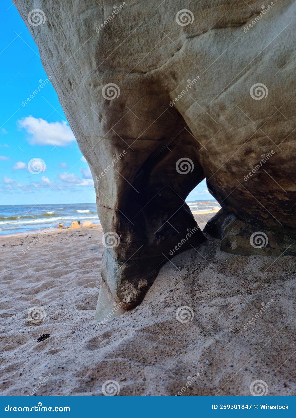Vertical Shot of a Large Rock at the Beach of the Baltic Sea Under a ...