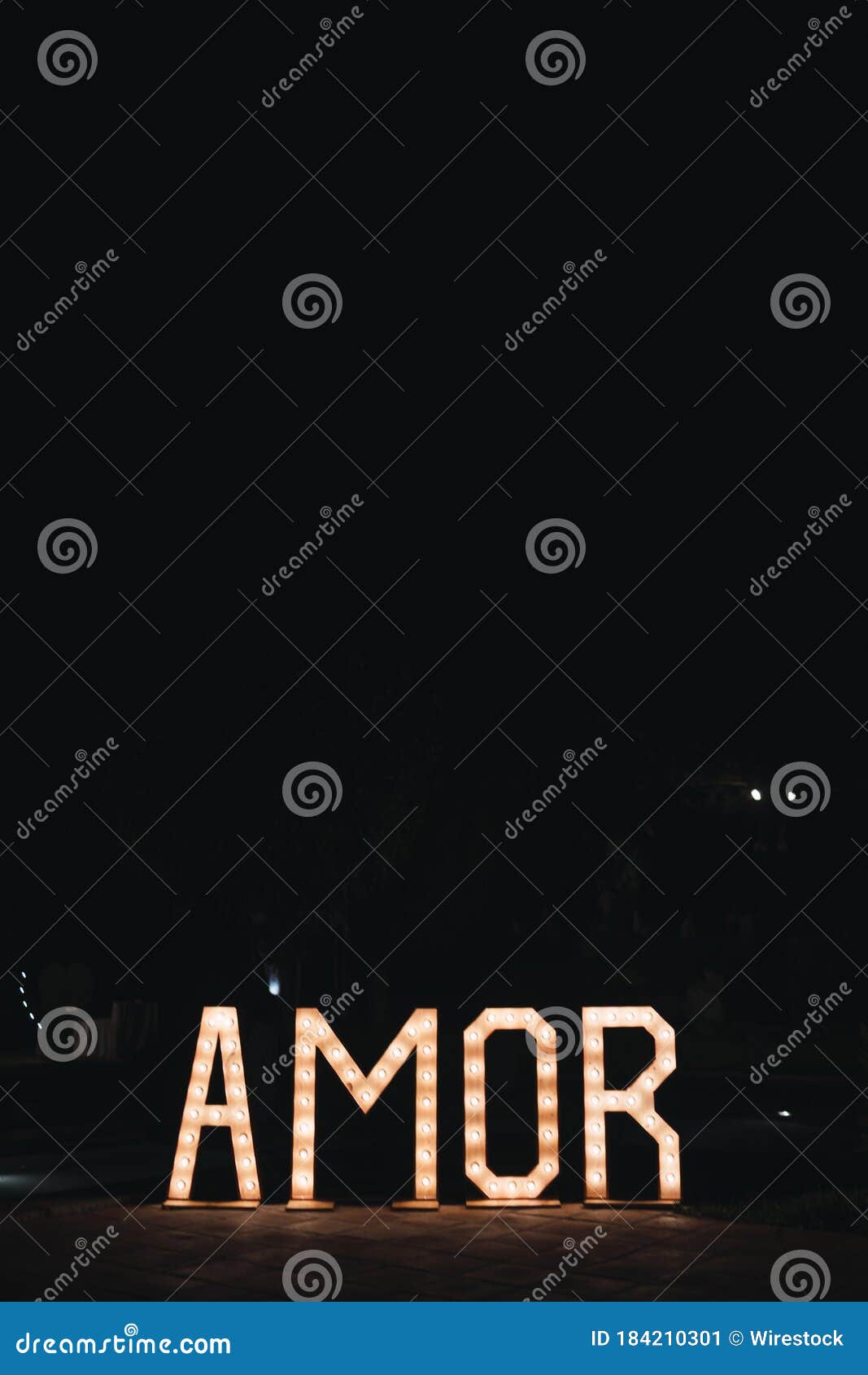 Vertical Shot of Letters-shaped Lights Completing AMOR Text Together ...