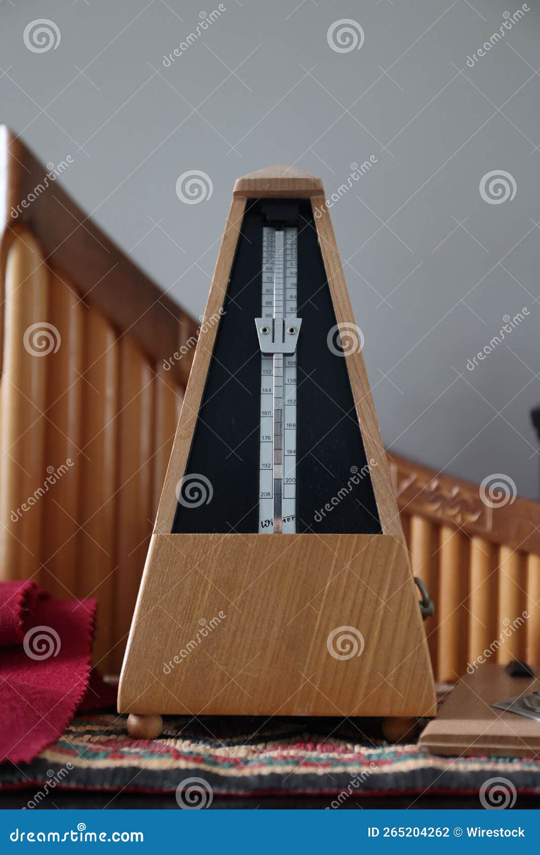 Vertical Shot of a Light Brown Metronome on a Table Stock Photo - Image ...