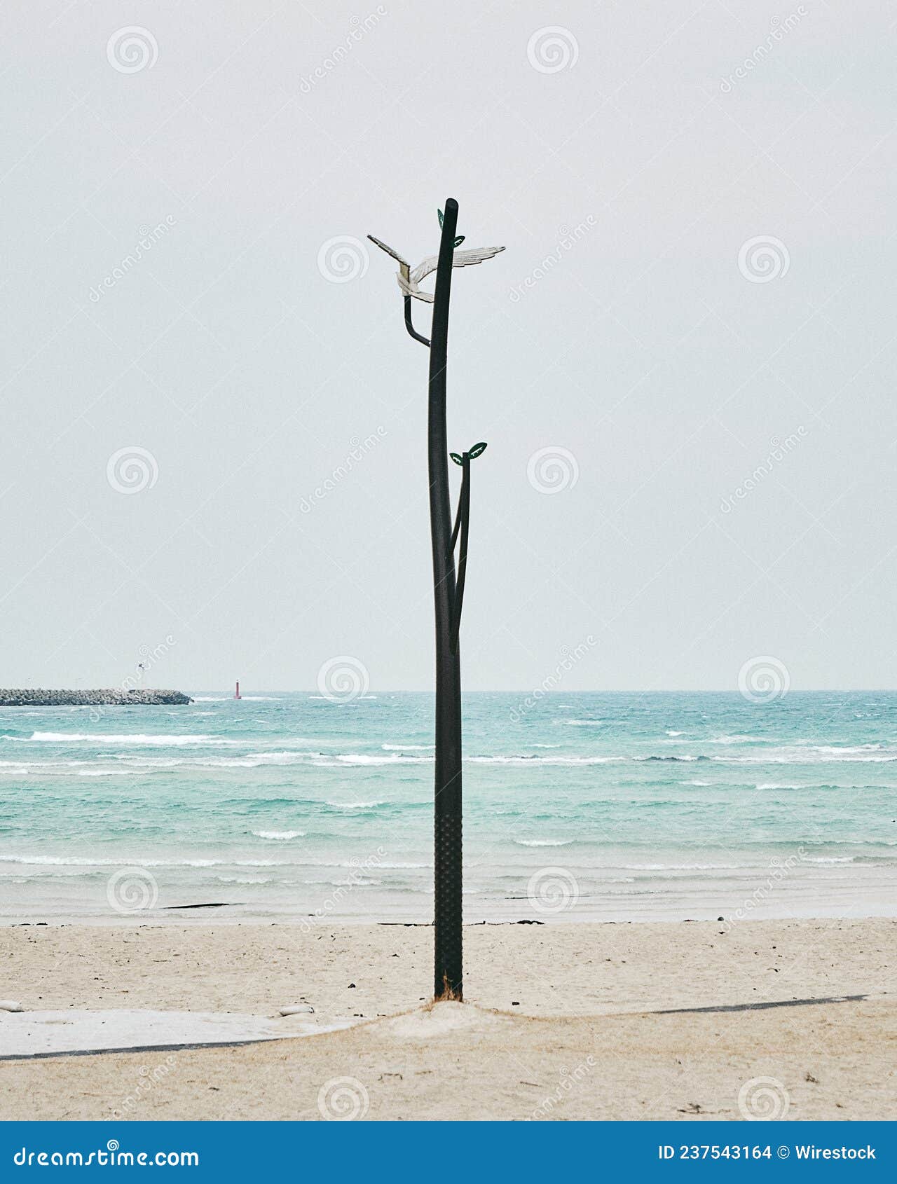 Vertical Shot of a Long Pole on a Beach Stock Photo - Image of water ...
