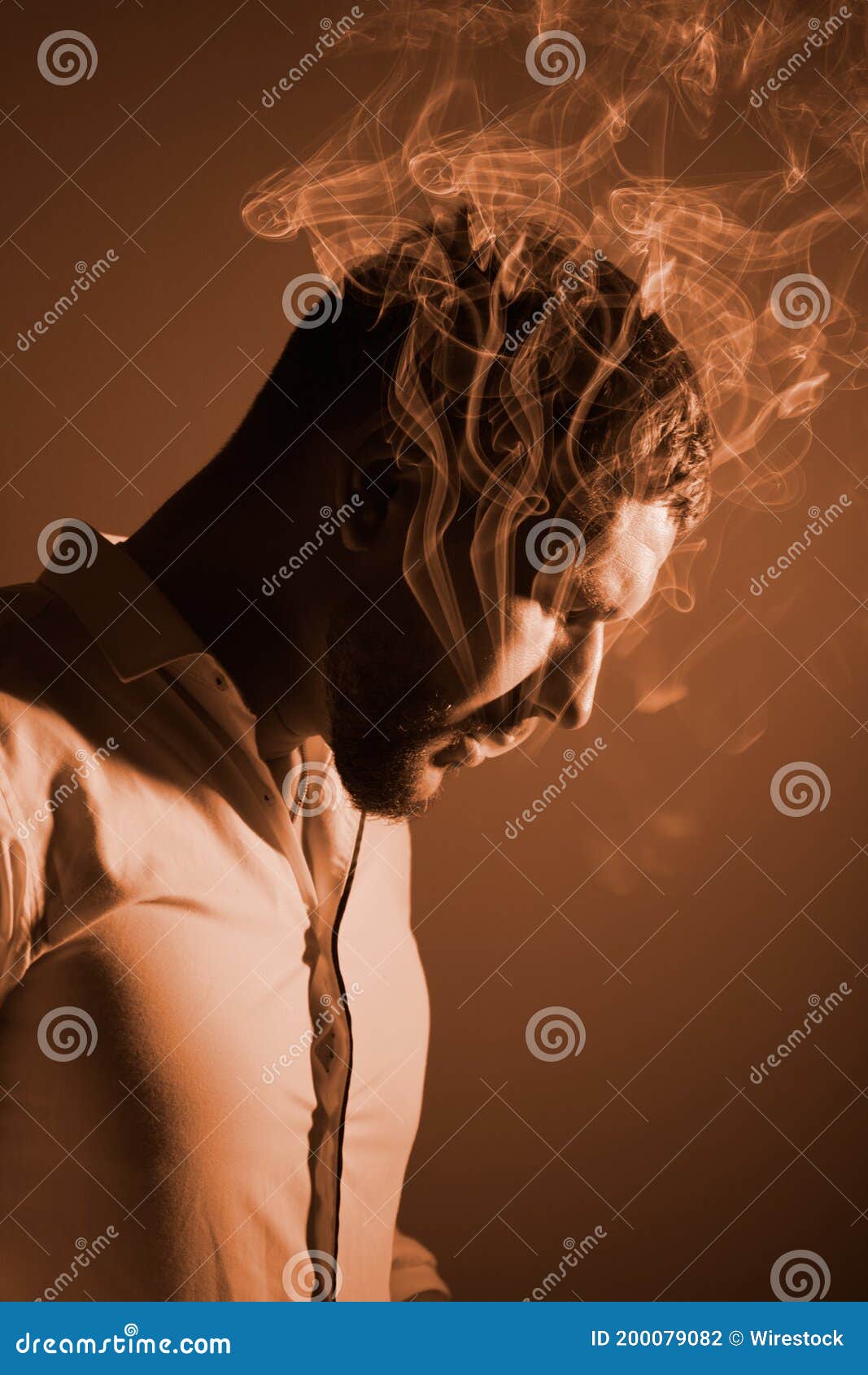 Vertical Shot of a Male Person Blowing Smoke with a Backlight Effect ...