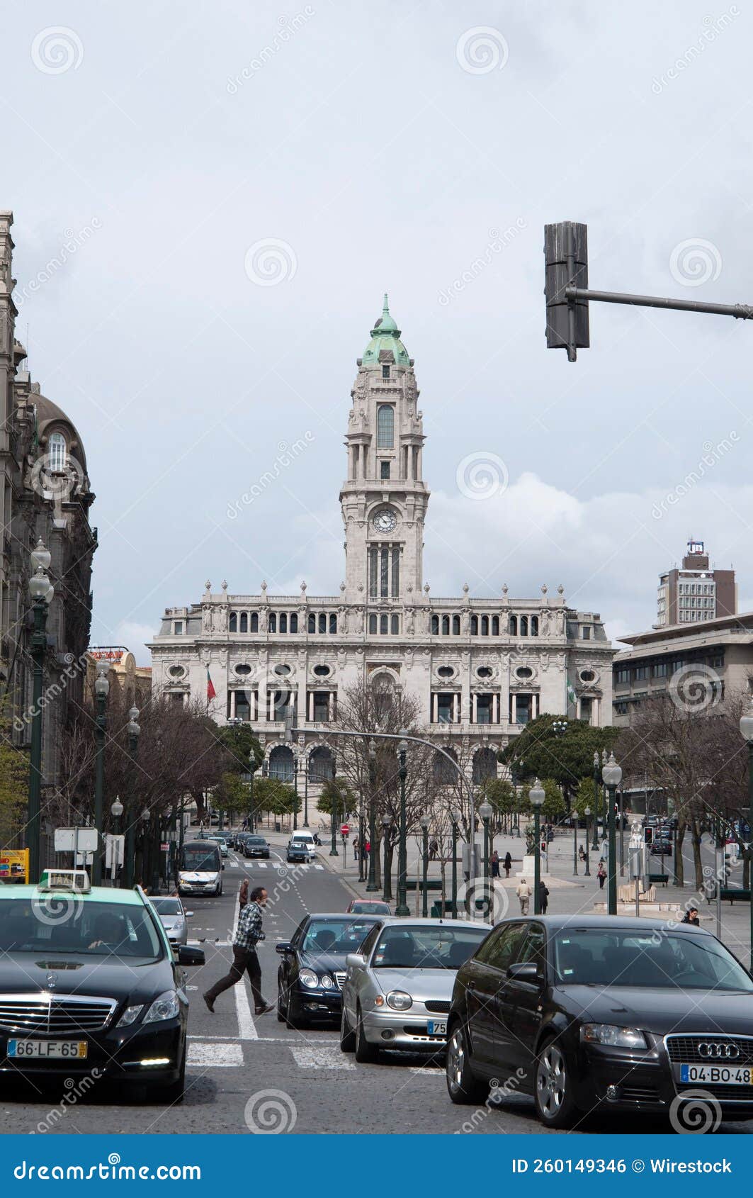 Vertical Shot of a Man Crossing Street between Cars and Beautiful ... Vertical Shot of a Man Crossing Street between Cars and Beautiful ...