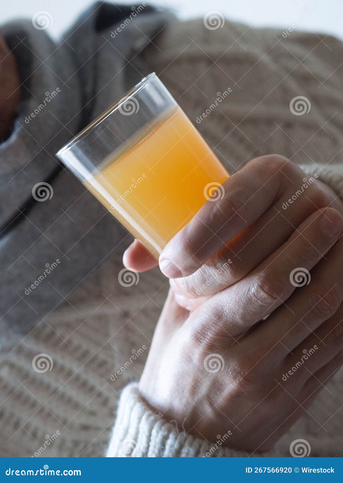 Vertical Shot of a Man Drinking a Cup of Orange Juice Stock Photo ...