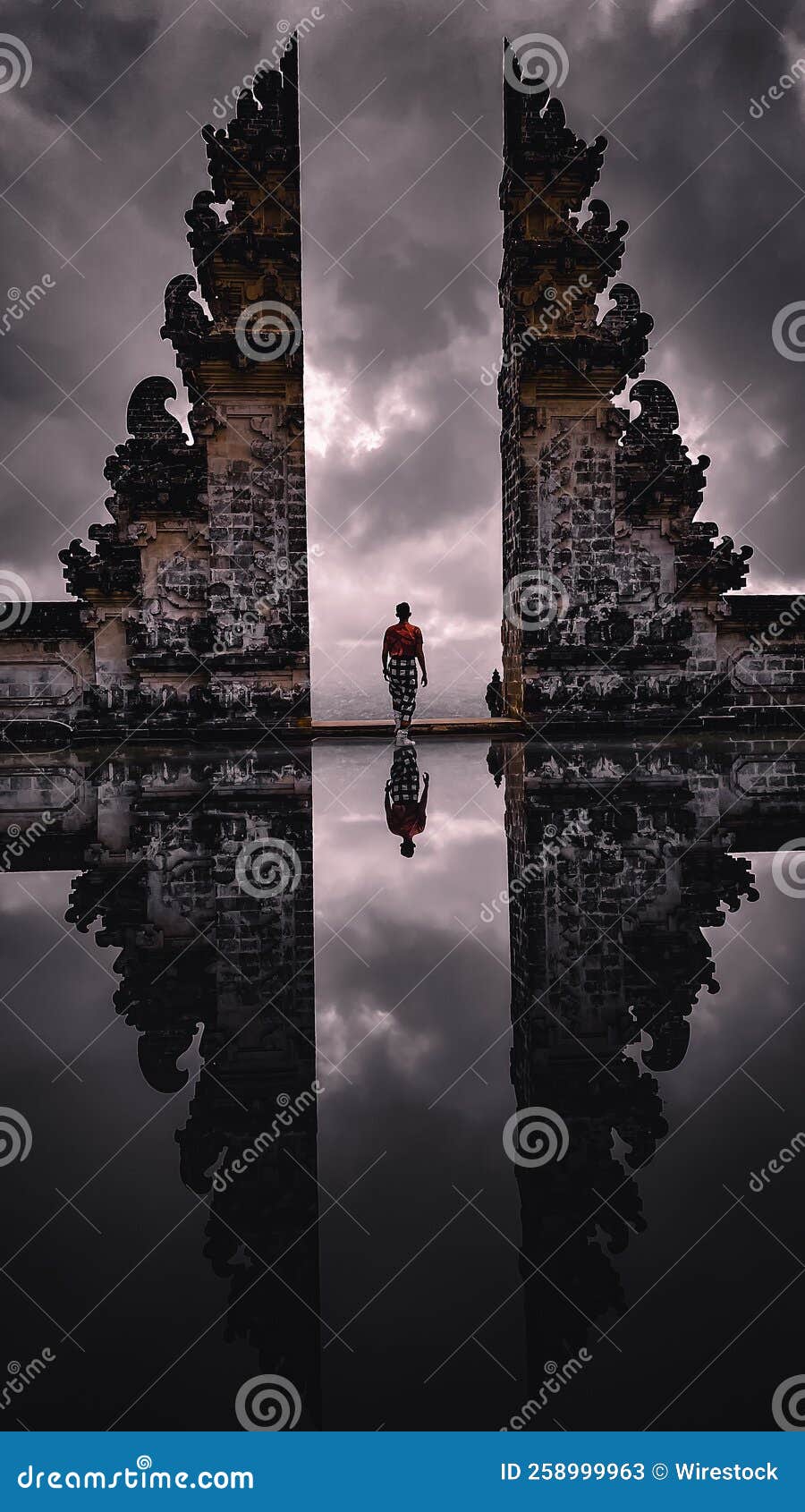 Vertical Shot of a Man between the Gates of Lempuyang Temple, with ... Vertical Shot of a Man between the Gates of Lempuyang Temple, with ...
