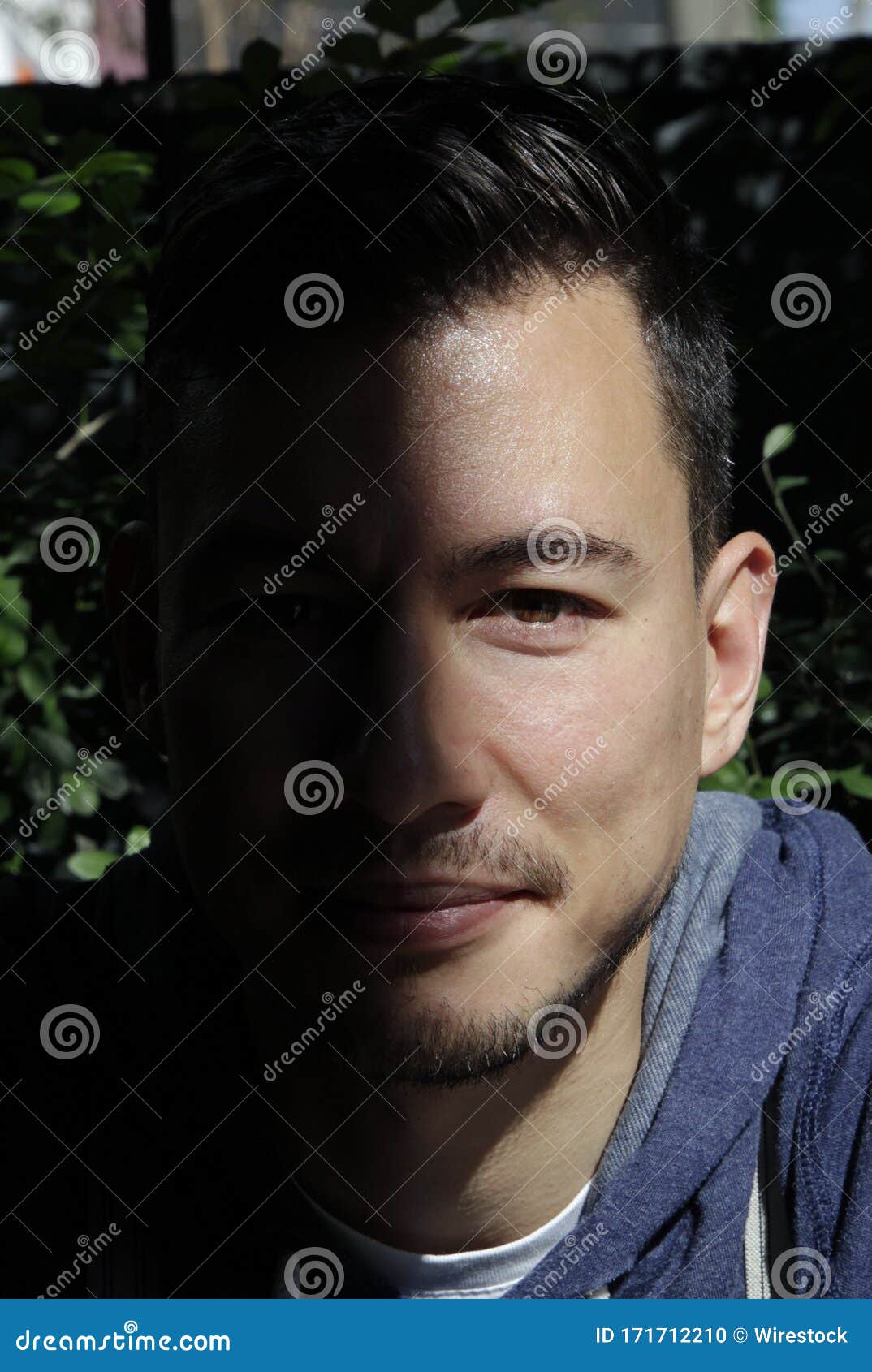 Vertical Shot of a Man Having Half of His Face Covered in Shadow Stock ...