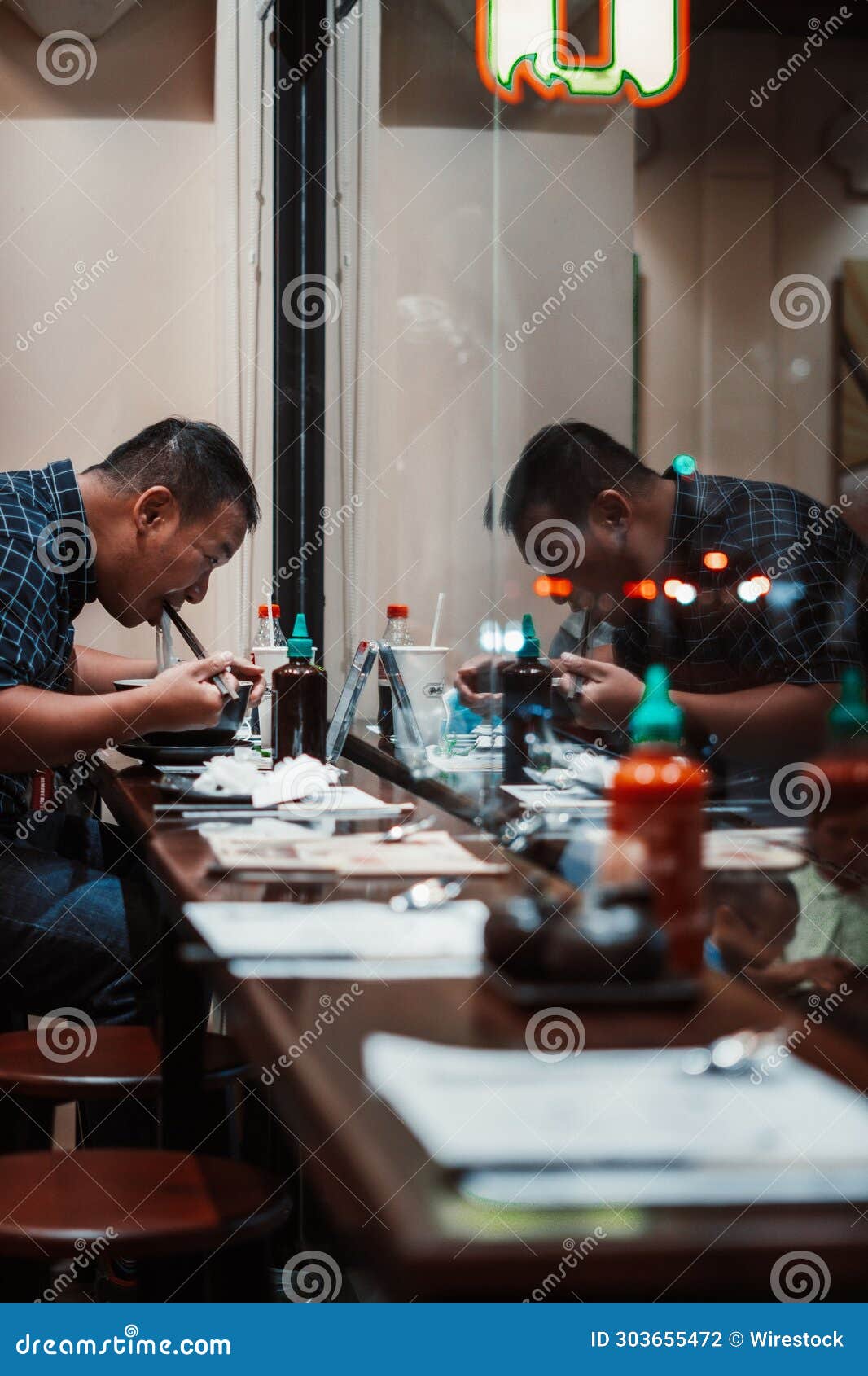 Vertical Shot of the Man Signing a Paper with His Reflection on the ...